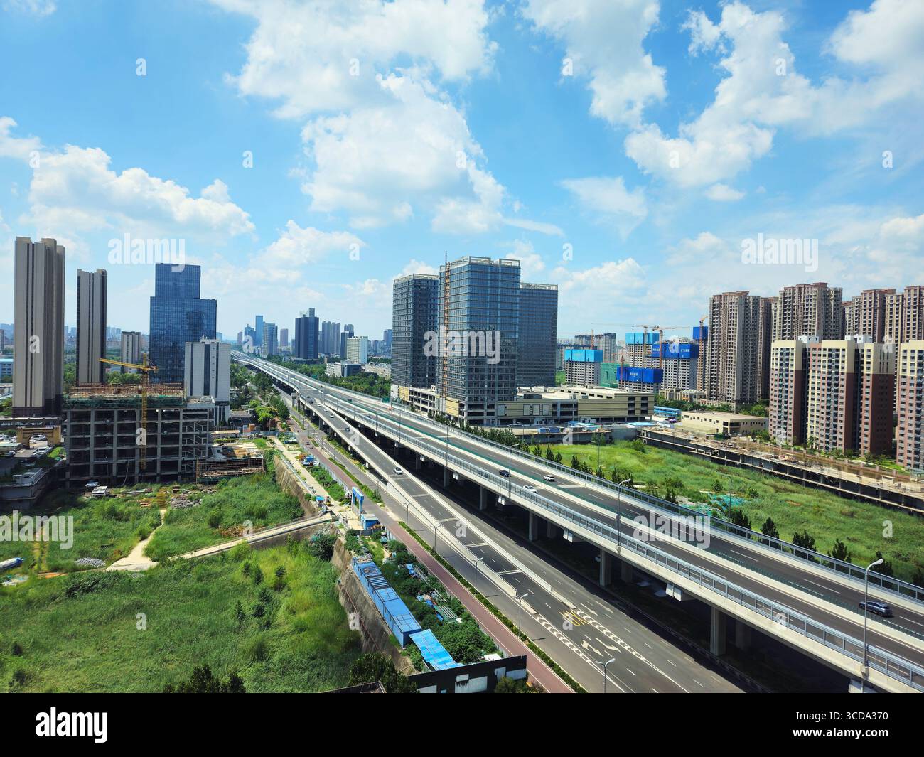 Sprawling skyline with some unfinished high-rise buildings behind a ...