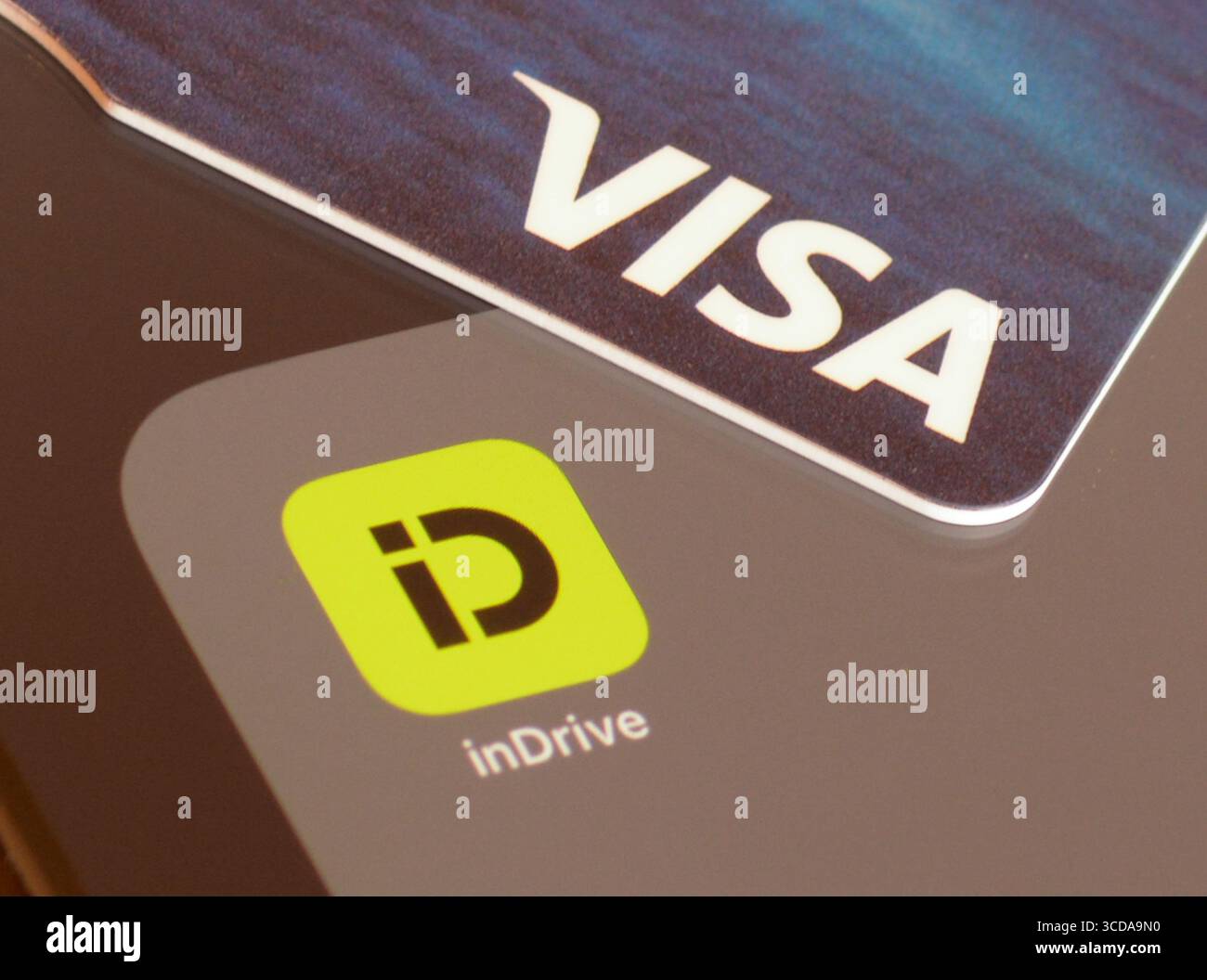 Indrive ride hailing app on smartphone screen with visa card hi-res ...