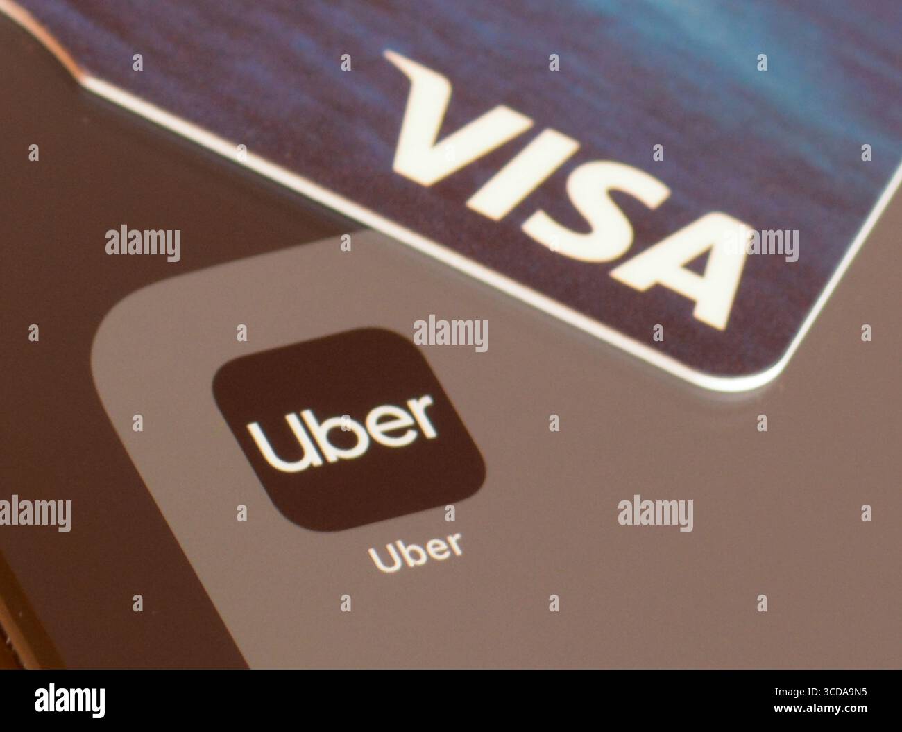 Uber taxi app on smartphone screen with VISA card for payment Stock ...