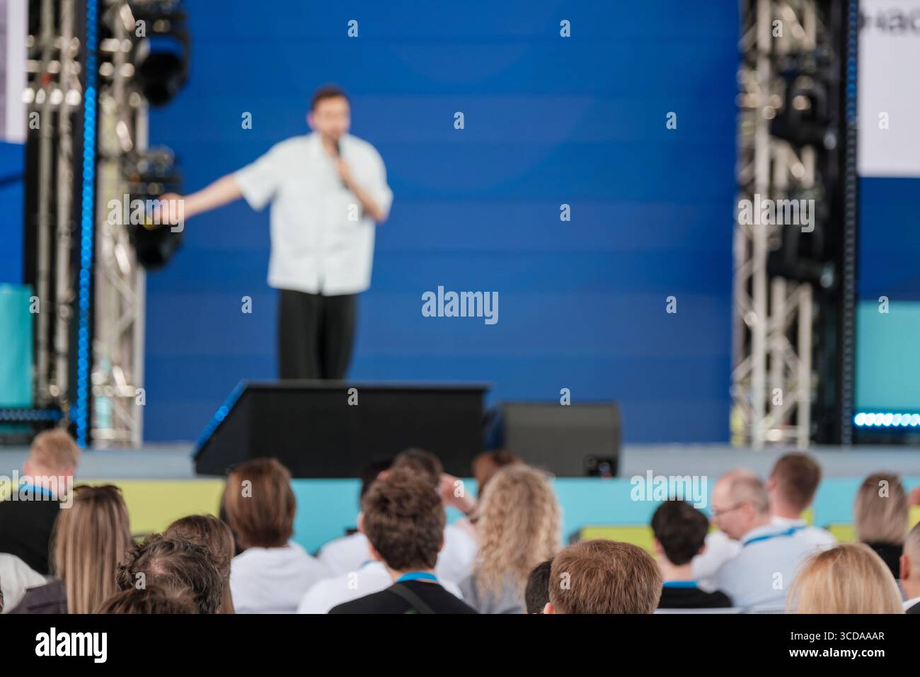 Blurred presenter speaks microphone conference hi-res stock photography ...