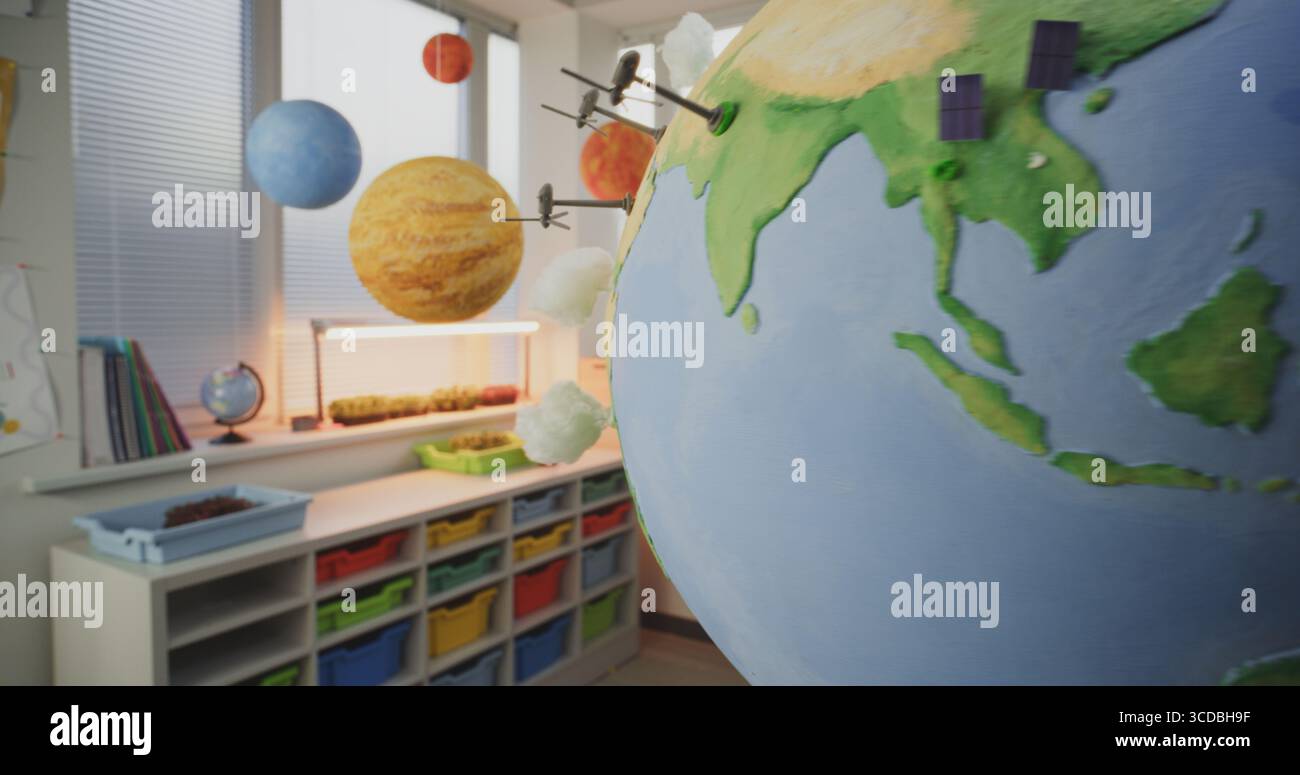 Modern STEM Classroom: Close Up of Rotating Earth Model with Miniature ...