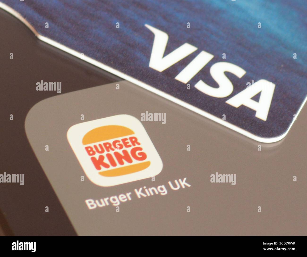 Burger King UK app on smartphone screen with a VISA card to make ...
