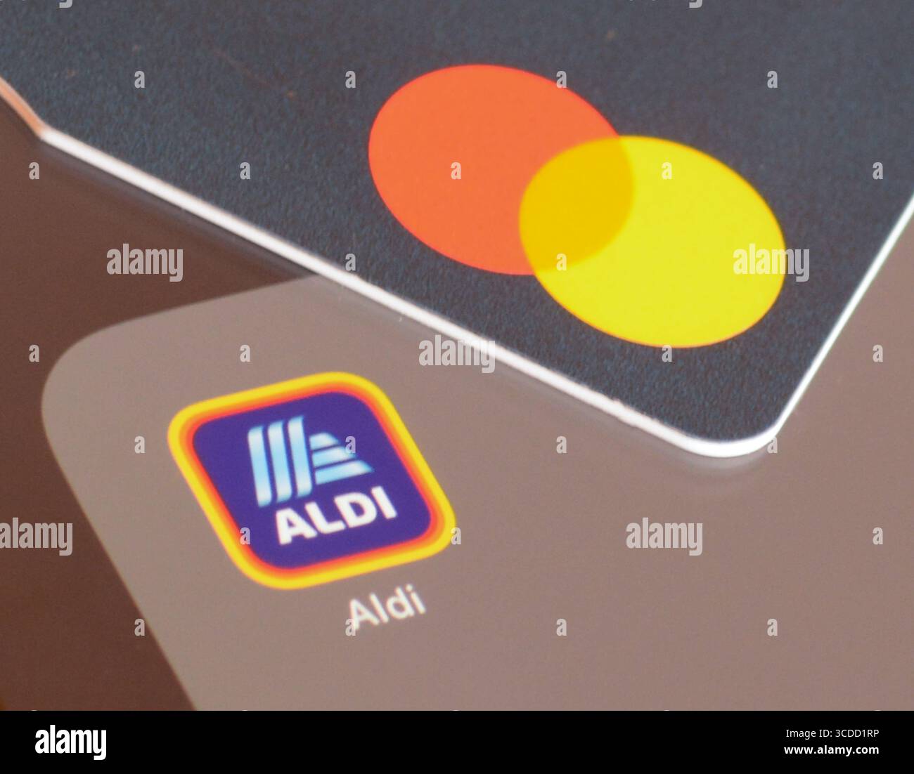 Aldi supermarket app on smartphone screen with a Mastercard to make ...