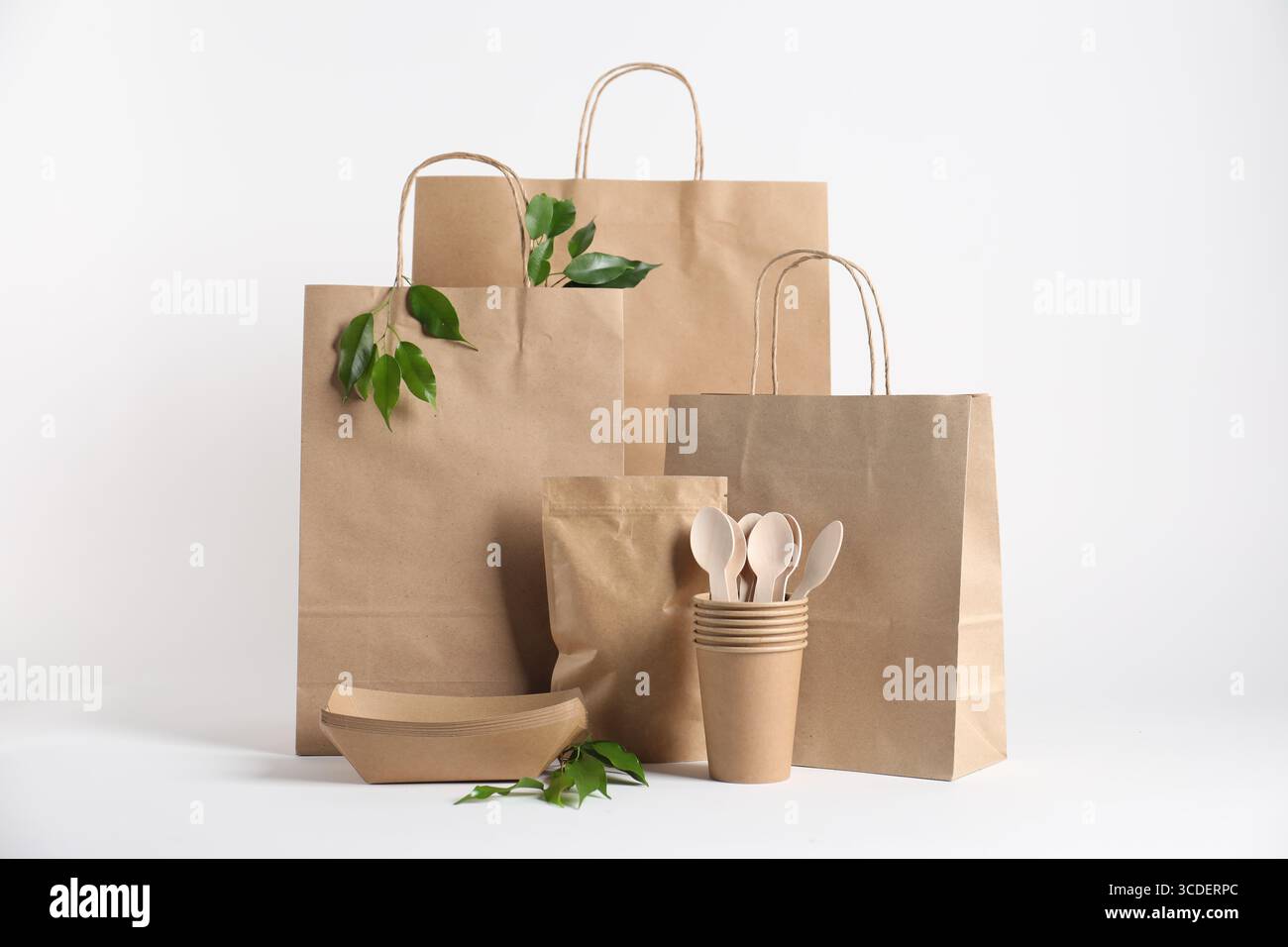 Different eco friendly packaging and leaves on white background Stock ...