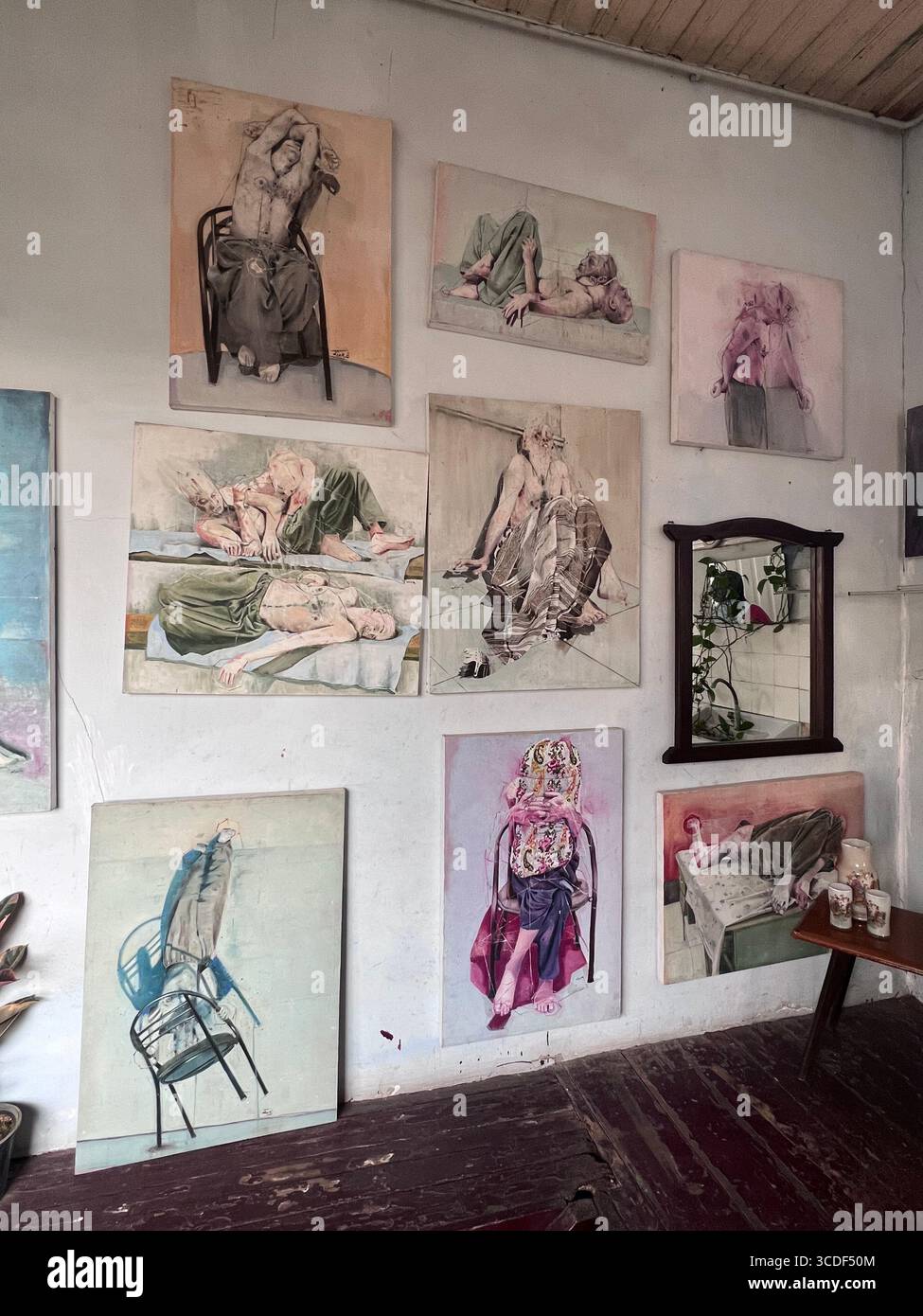 Artistic wall with modern expressive paintings and cozy décor inside ...