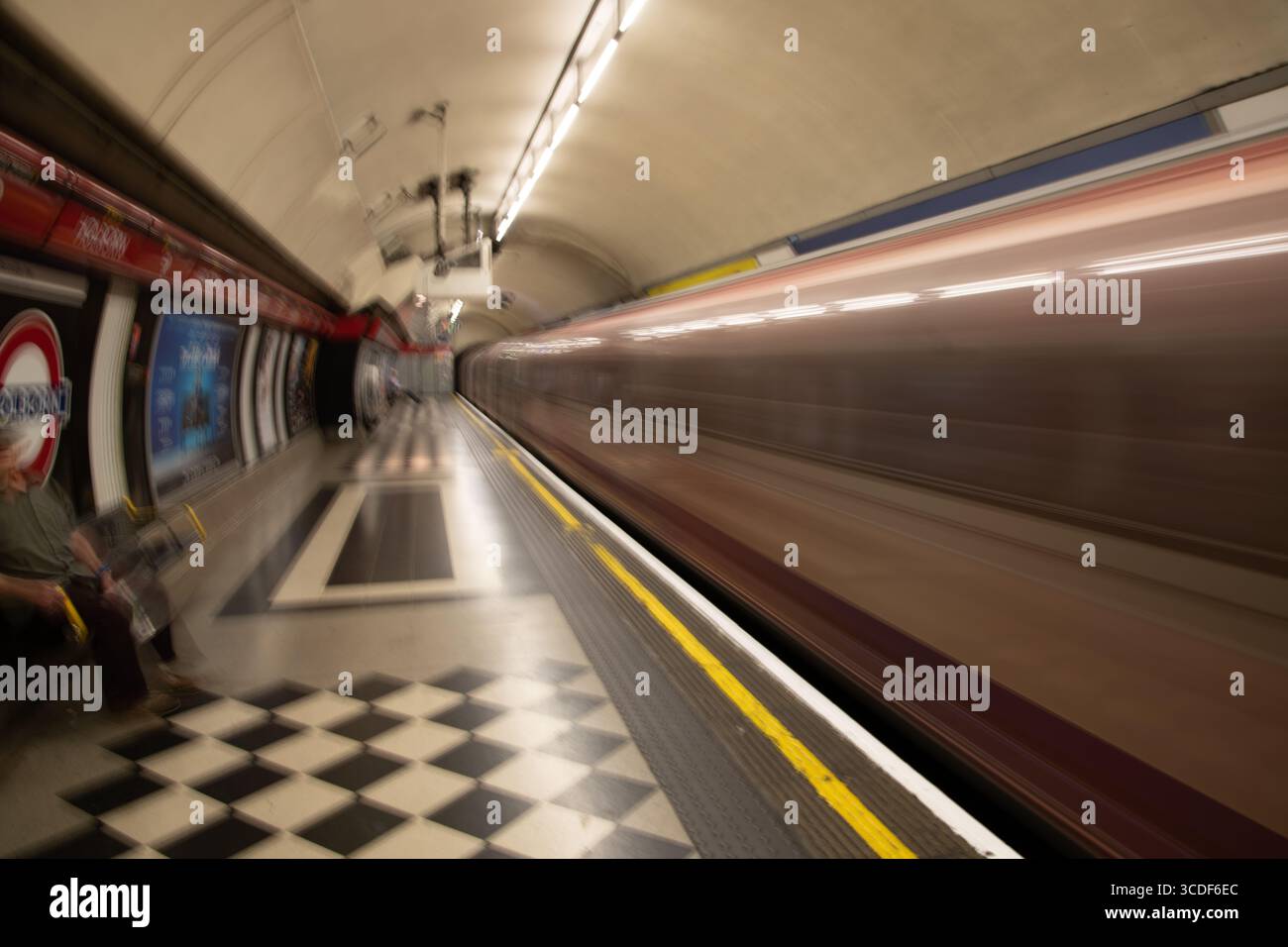 Motion-blurred Central Line train arriving at Holborn station on the London Underground ...