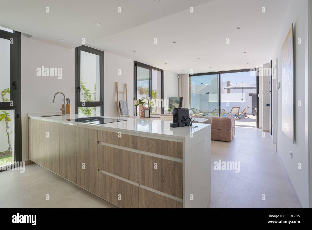Bright open-plan kitchen and living area with garden views and modern ...