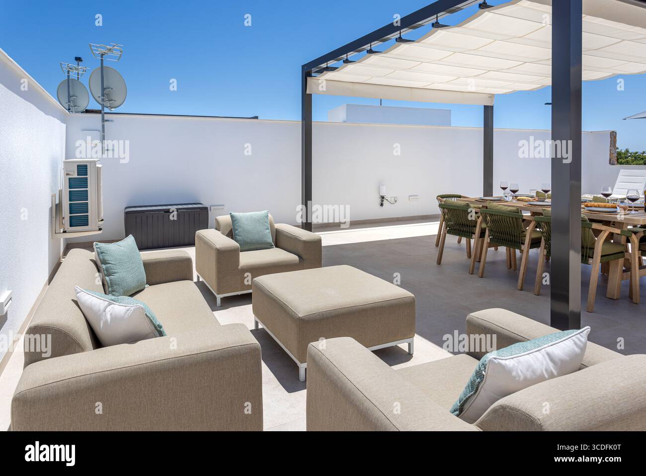Spacious rooftop with outdoor seating, shaded dining table and ...