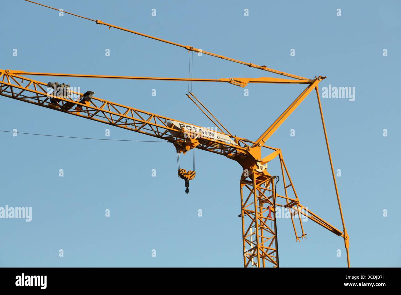 Tall construction crane on a building site Stock Photo - Alamy