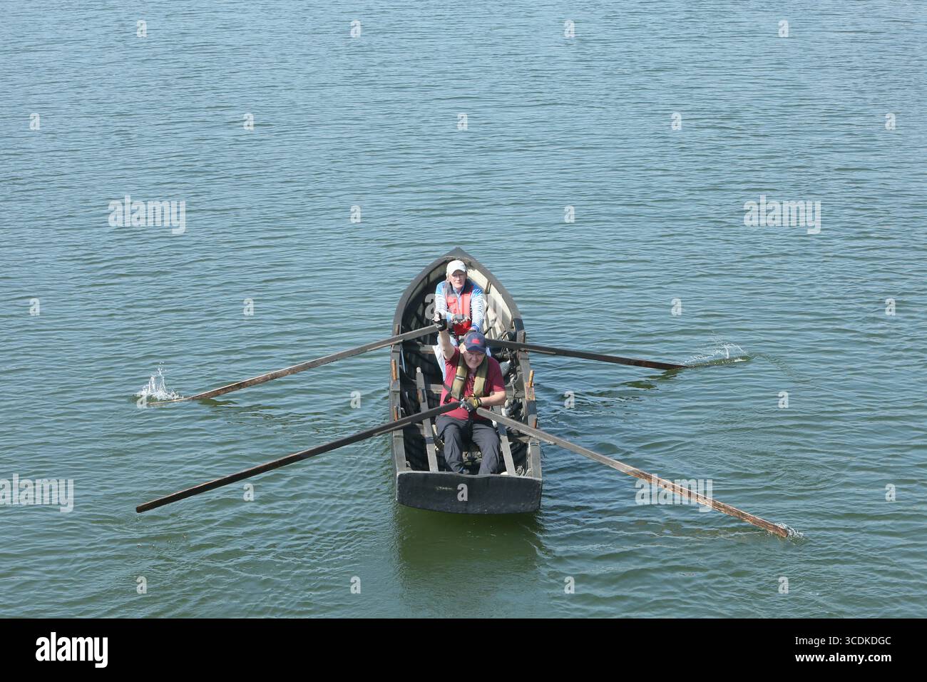 Dublin, Ireland - 13th August 2025 - A man waves while rowing a ...