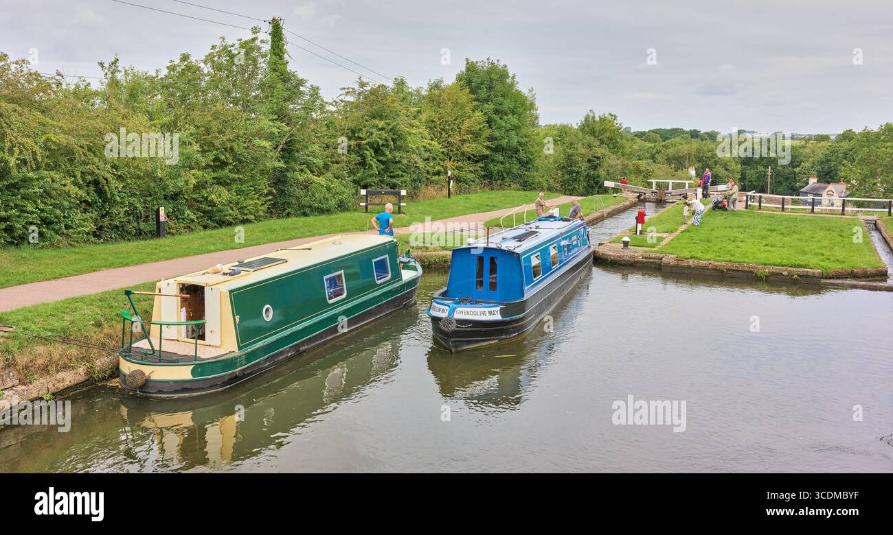 Two canal boats cross in the midway pool at Foxton locks, England Stock ...