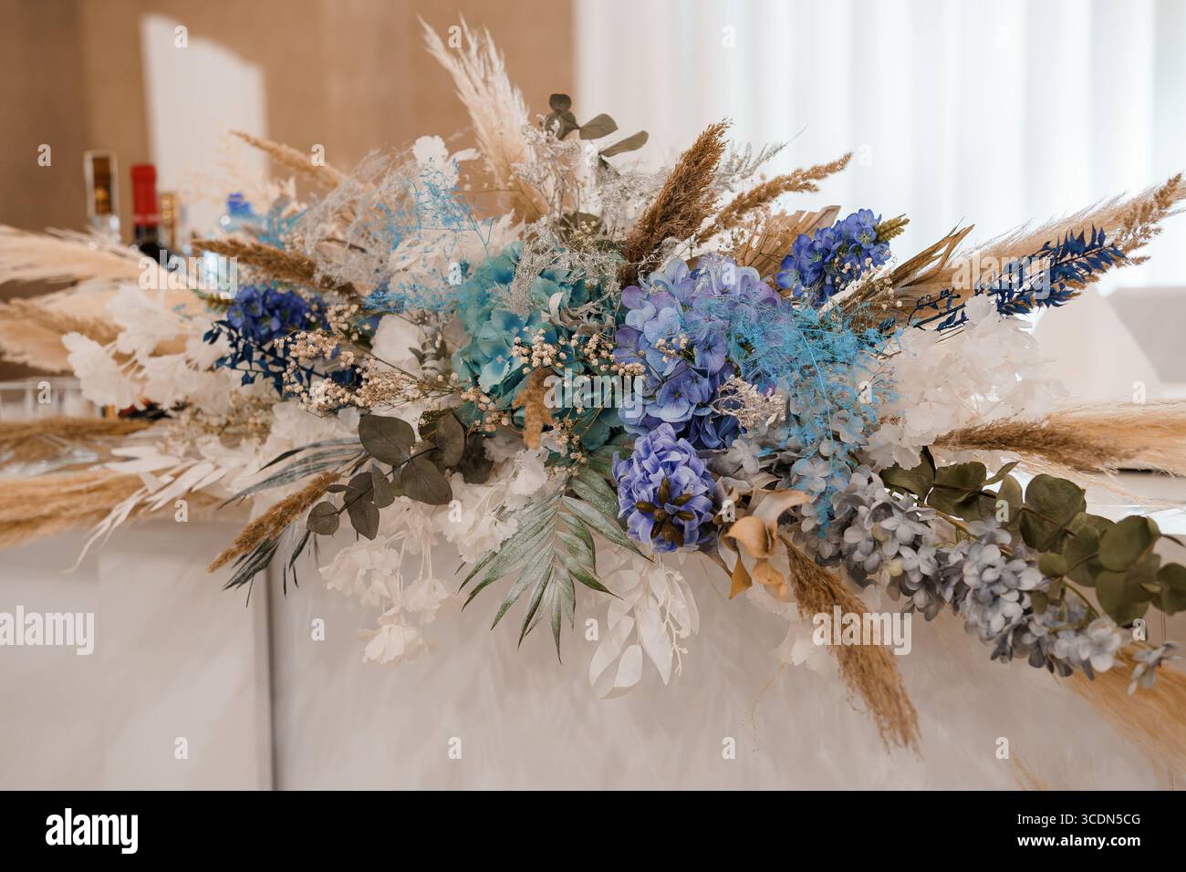 A long table runner displays a stunning wedding centerpiece, featuring ...