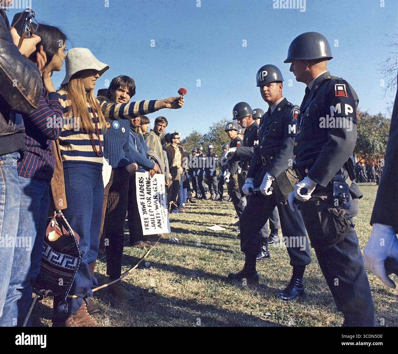 VIETNAM WAR A woman demonstrator offers a flower to military police on ...