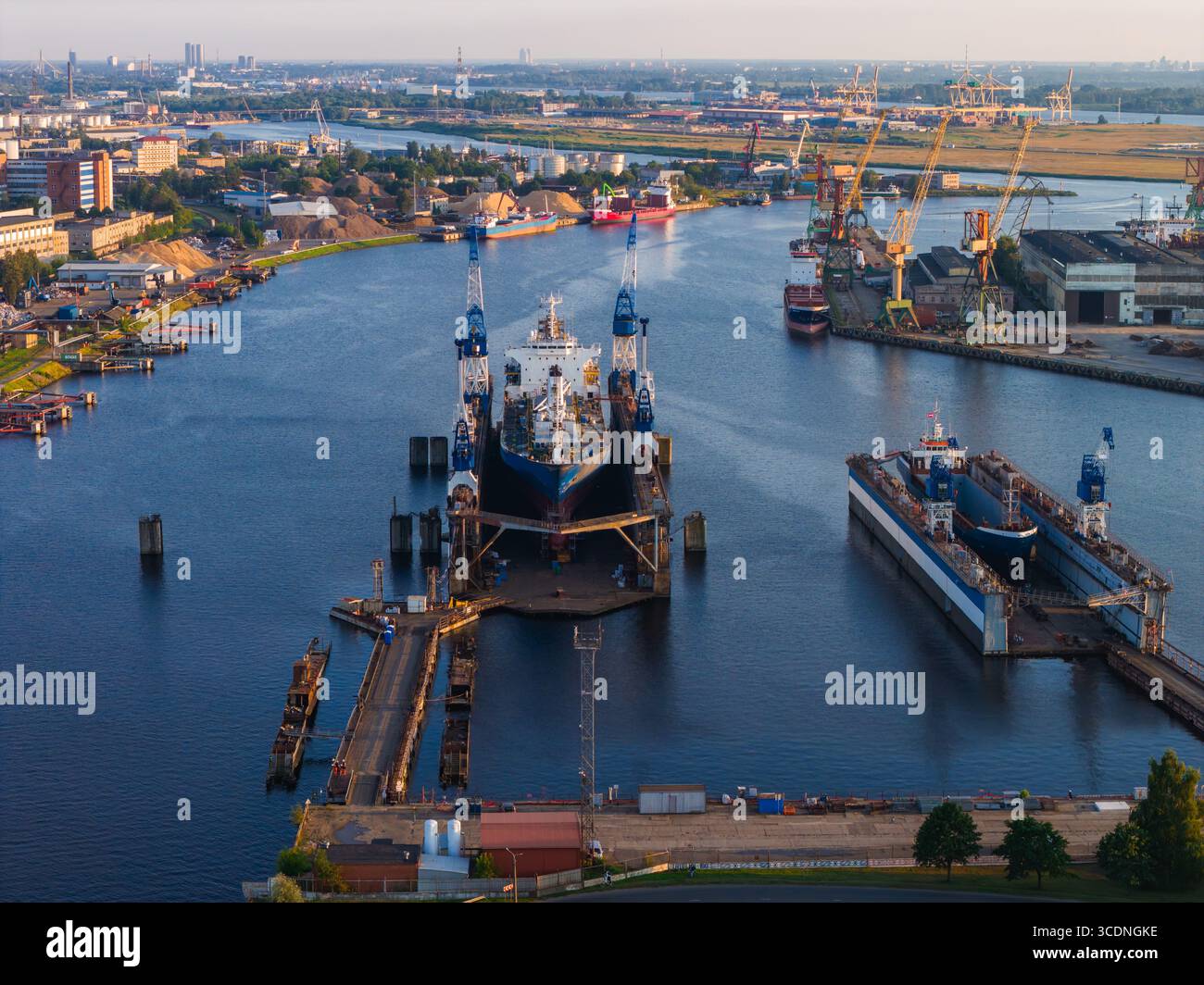 Shipyard in Riga, Latvia with Docked Vessels and City Skyline Stock ...