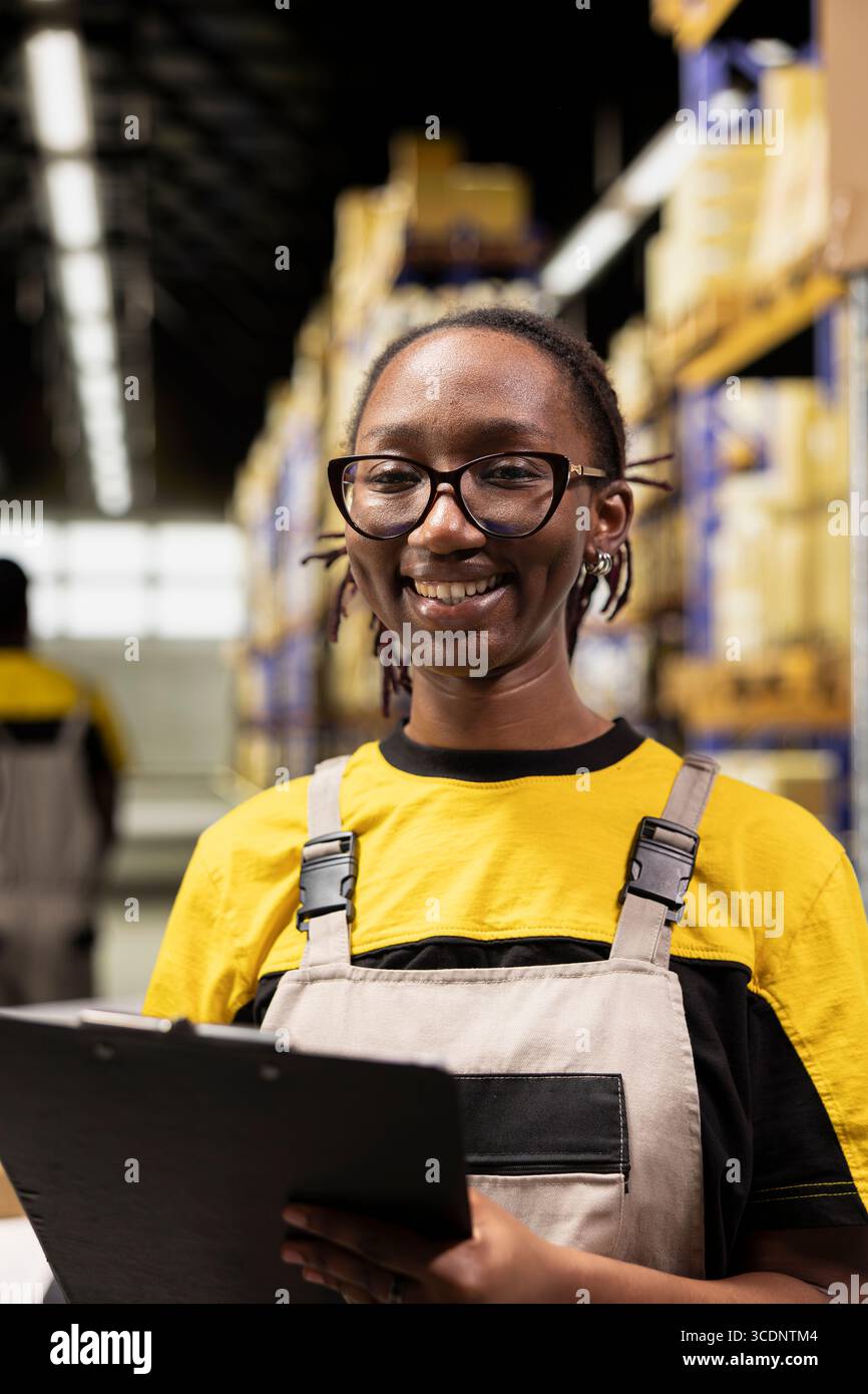 Portrait of African american cheerful staff manages pallets inventory ...