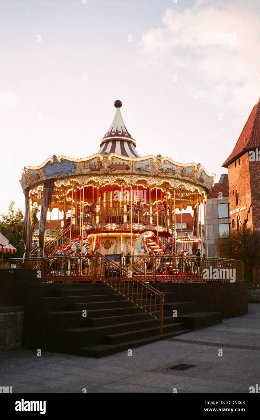 Colorful vintage carousel with ornate horses and decorative lights in ...