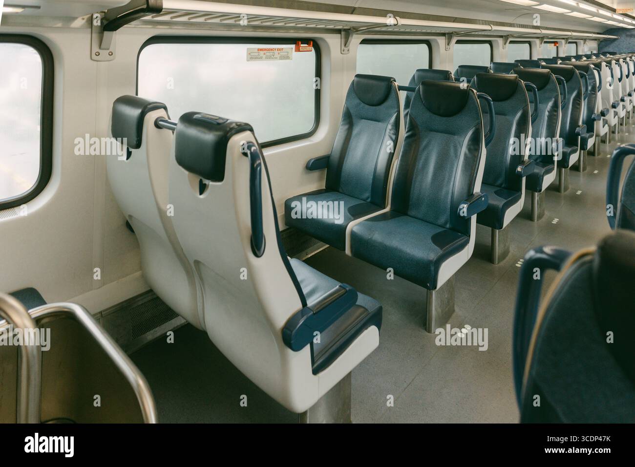 Modern train interior with spacious, empty seats designed for passenger ...