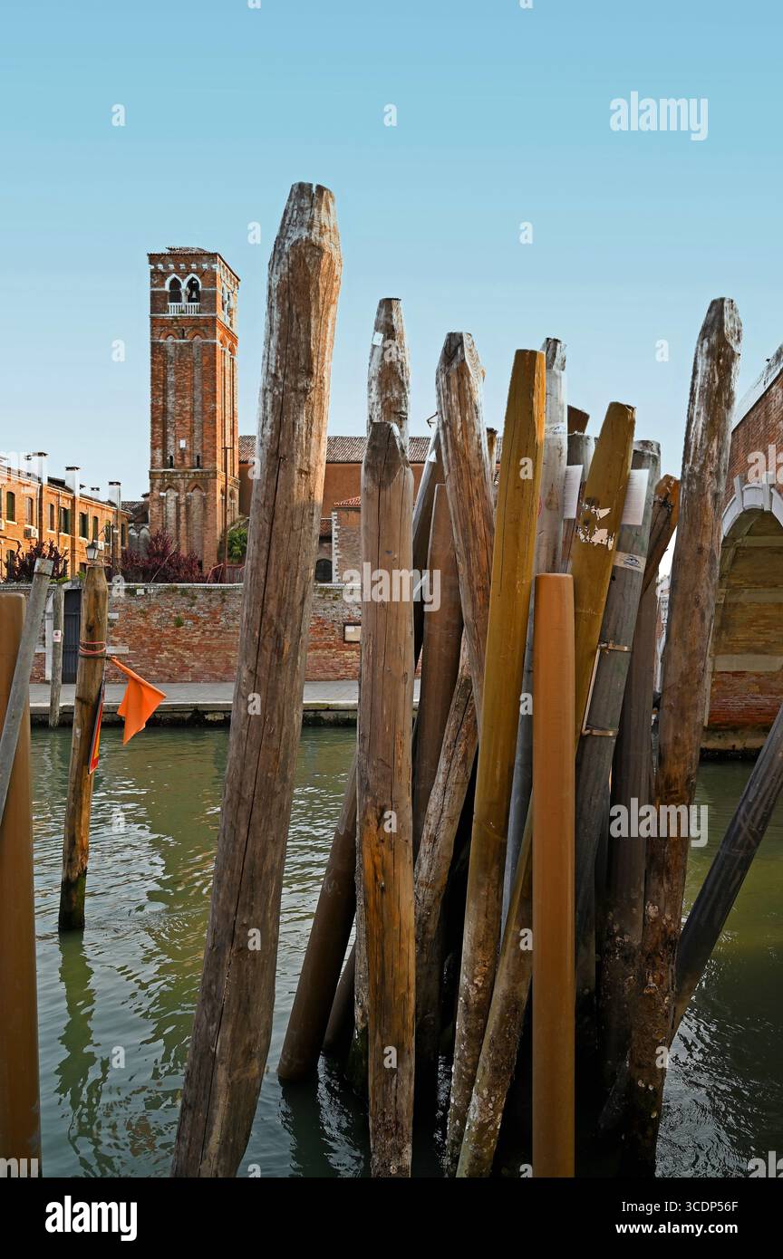 Venice, Italy. Wooden piles in a canal near a bridge in the Cannaregio ...