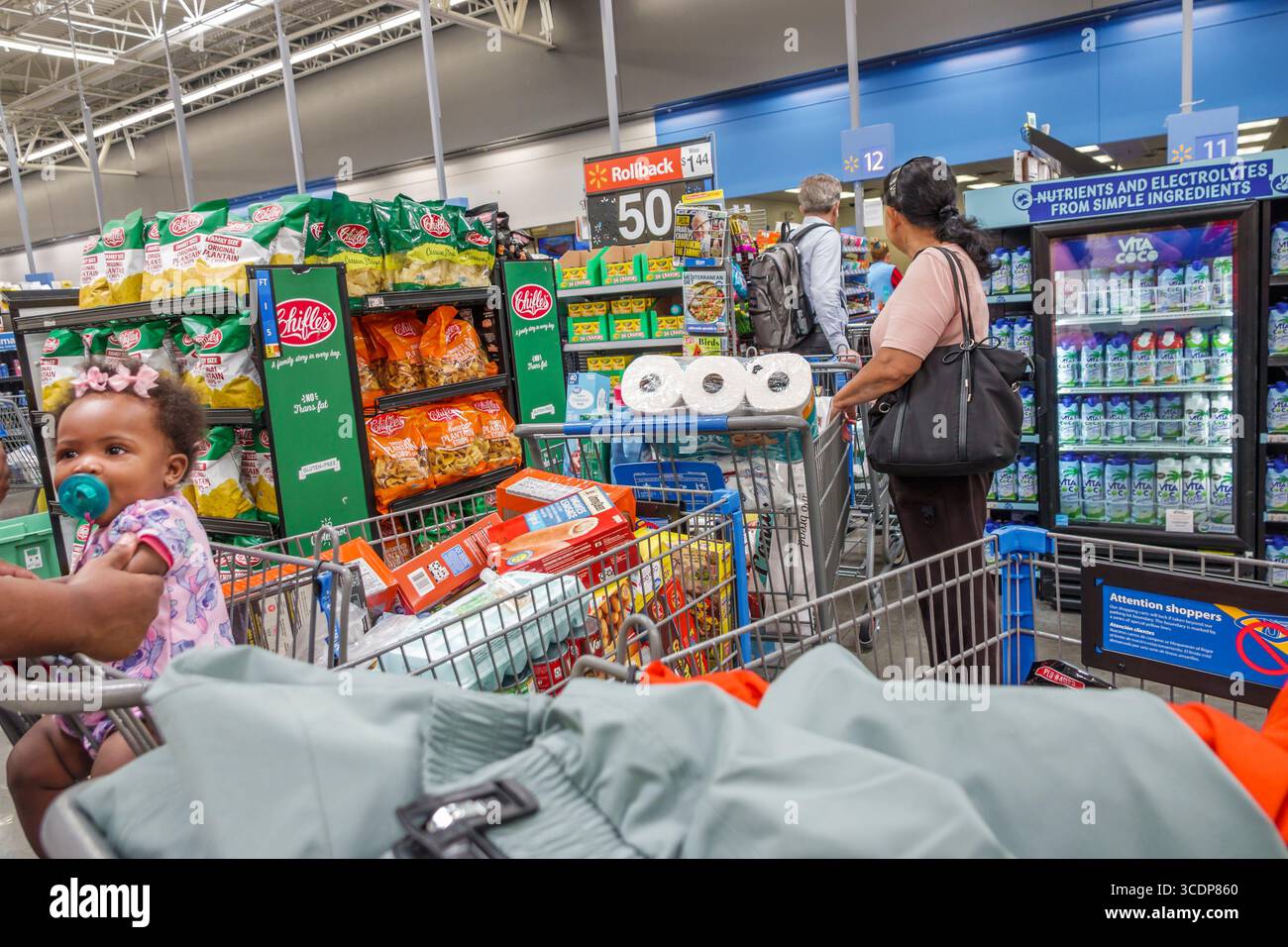 Shoppers buying snacks beverages household goods hi-res stock ...