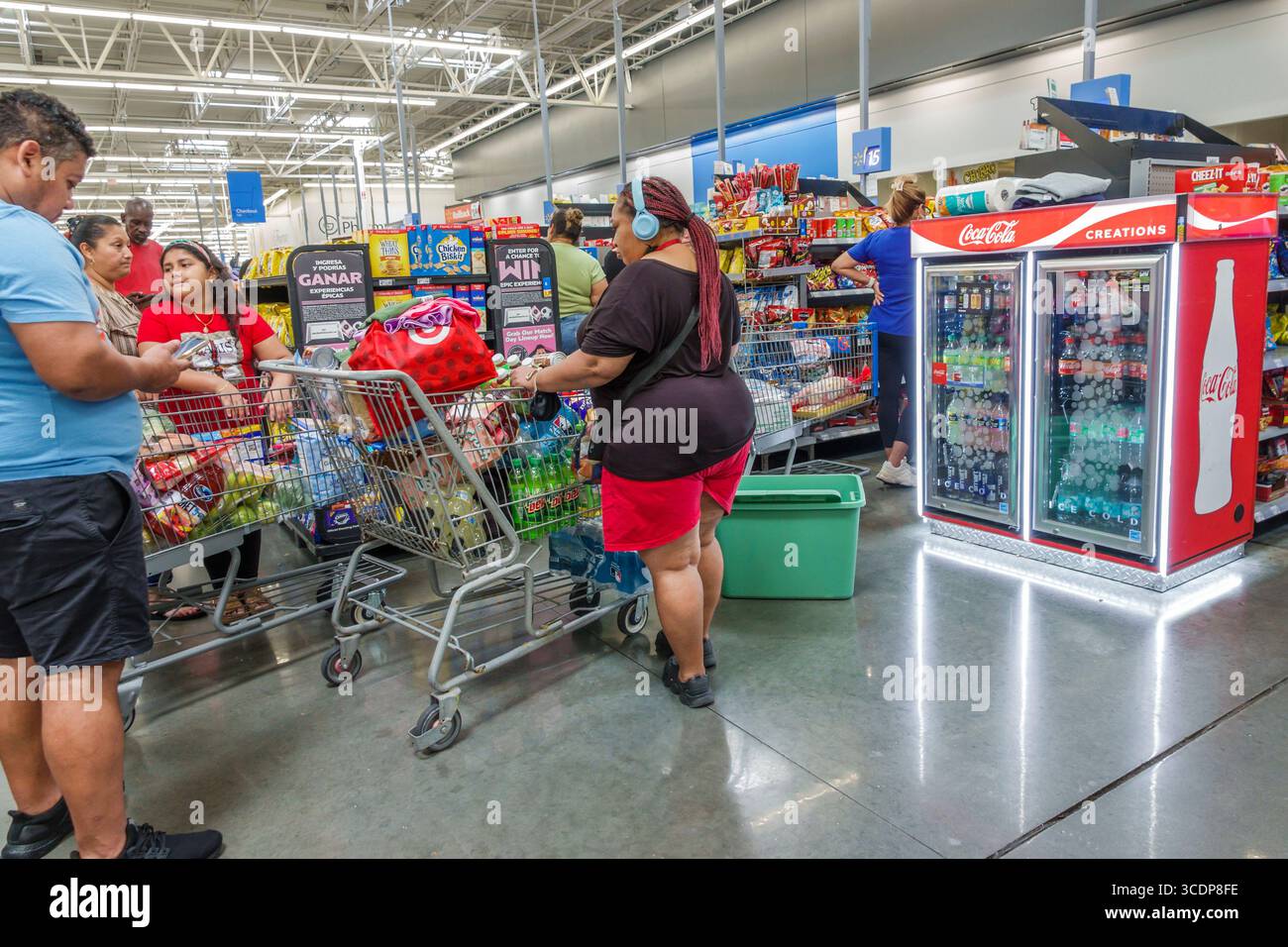 Pushing grocery cart trolley with bottled water soda snacks hi-res ...
