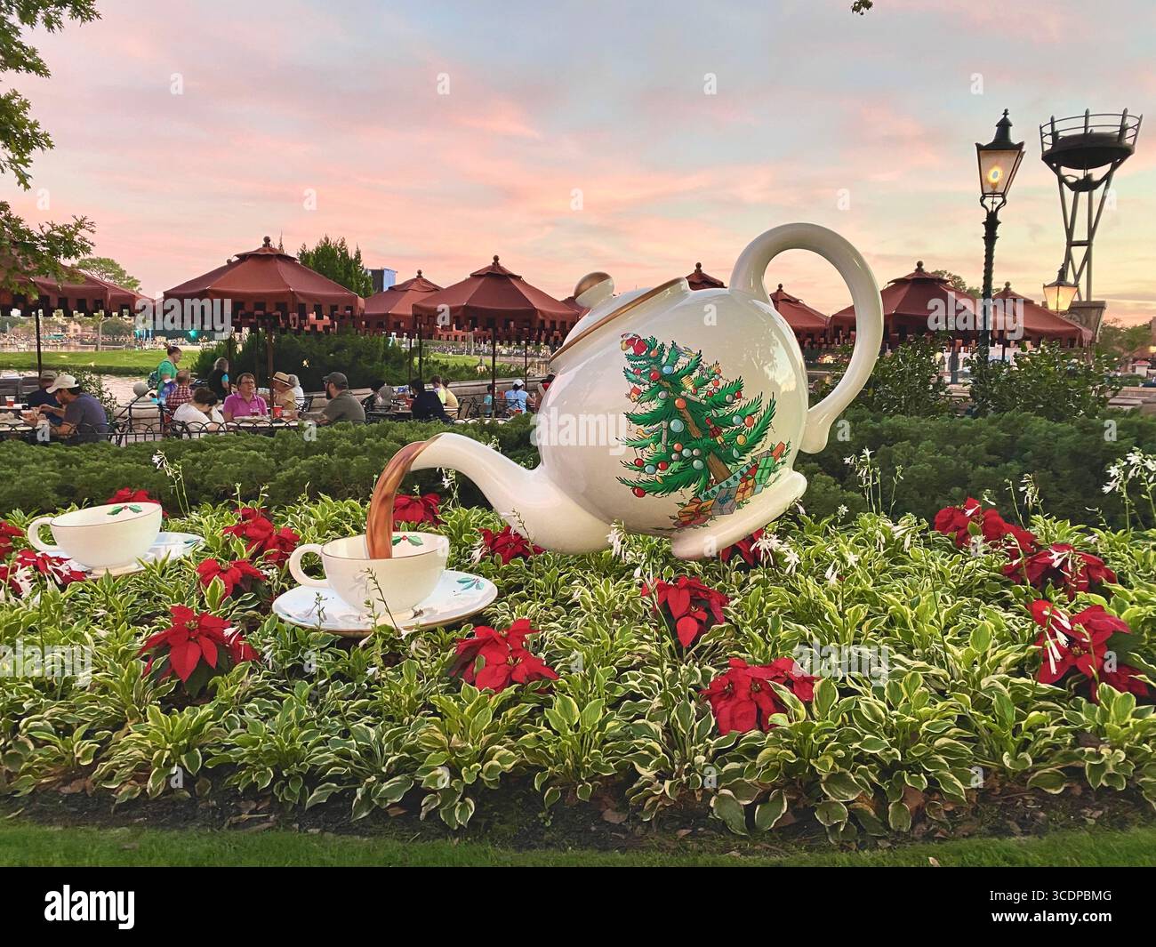 Christmas decorated teapot and cups displayed in a poinsettia adorned ...