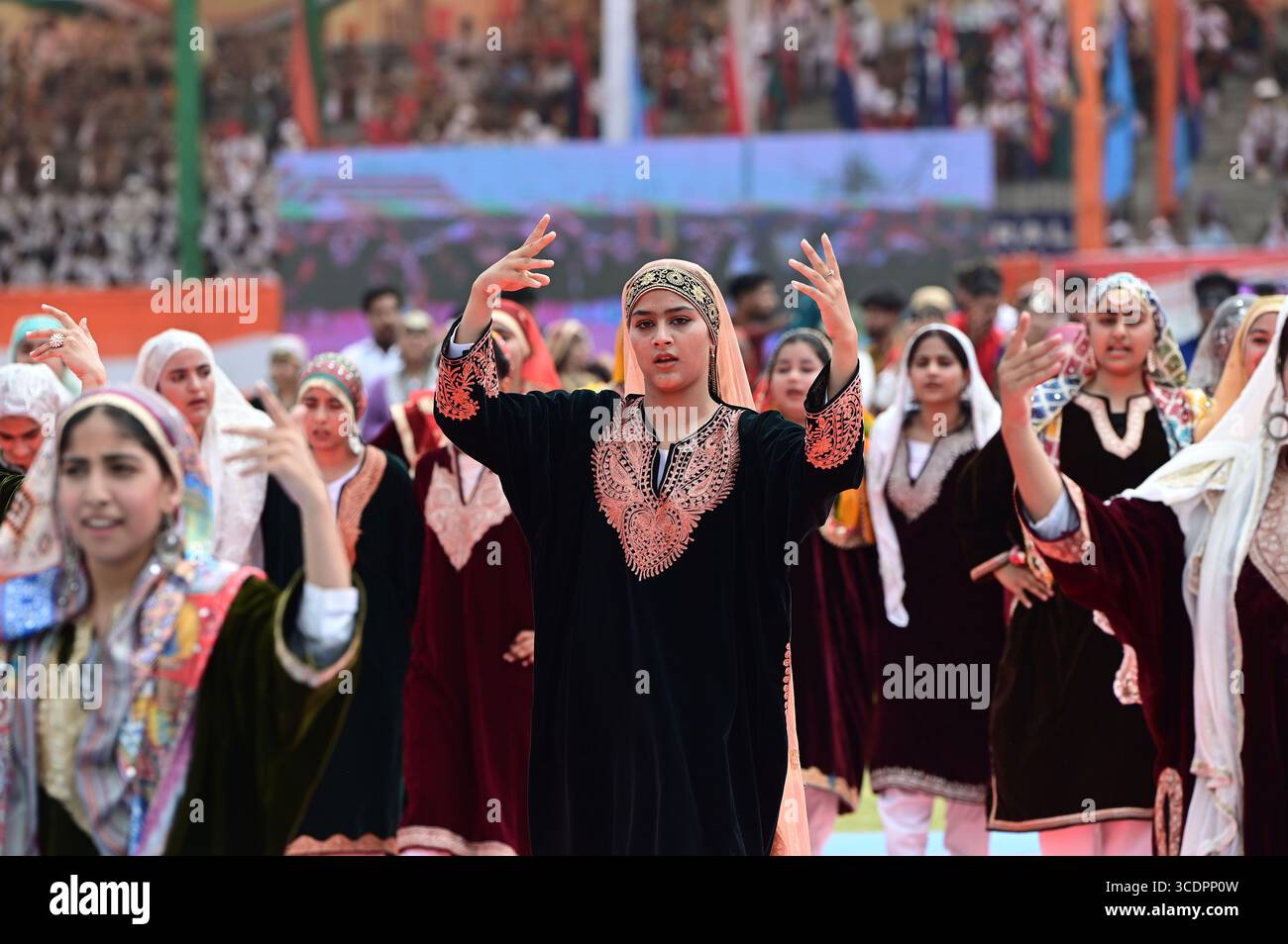 SRINAGAR, INDIA - AUGUST 13: School students in traditional Kashmiri attire perform during full ...