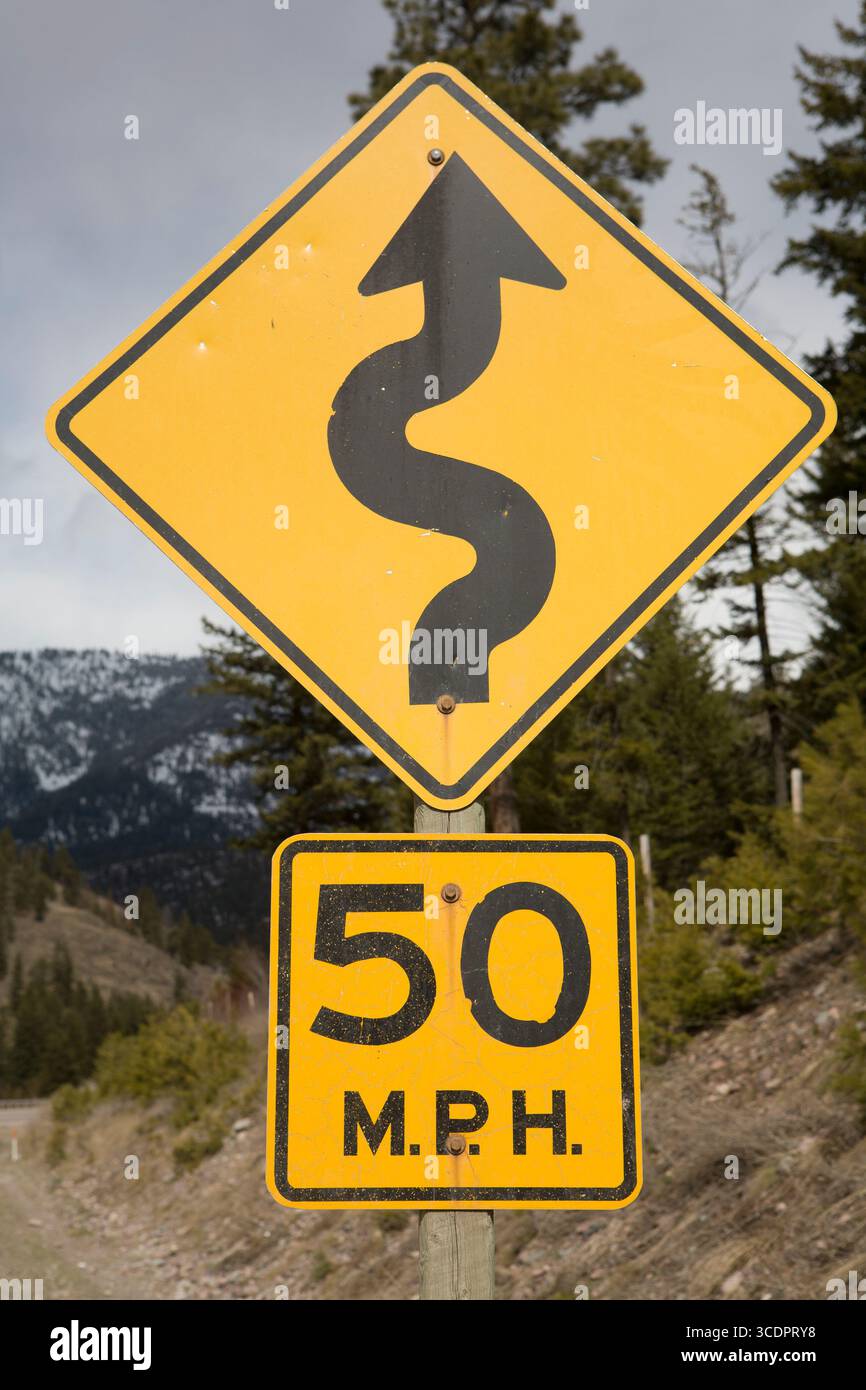 Curvy road hazard sign and 50mph advisory speed limit Stock Photo - Alamy