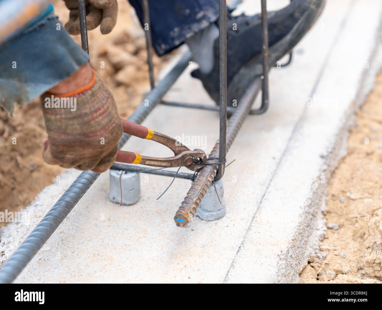 The construction worker ties reinforcing steel (rebar) for the floor ...
