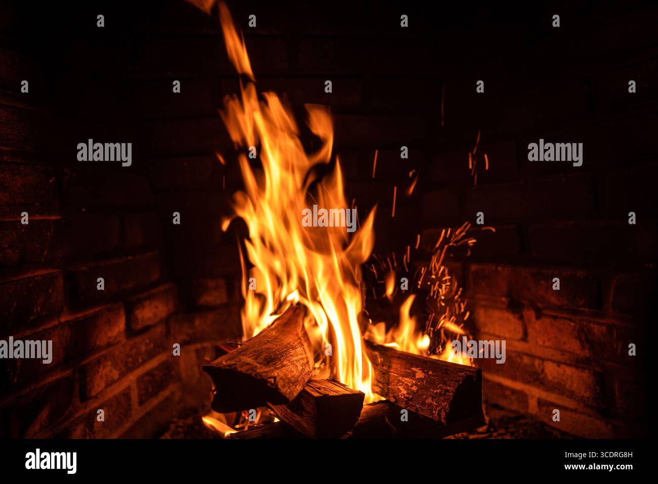 Roaring Fire in a Brick Fireplace Stock Photo - Alamy