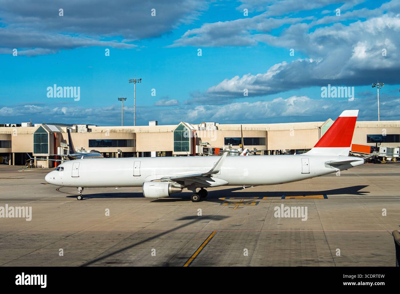 Commercial Airplane Positioned on Airport Tarmac with Cloudy Blue Sky ...