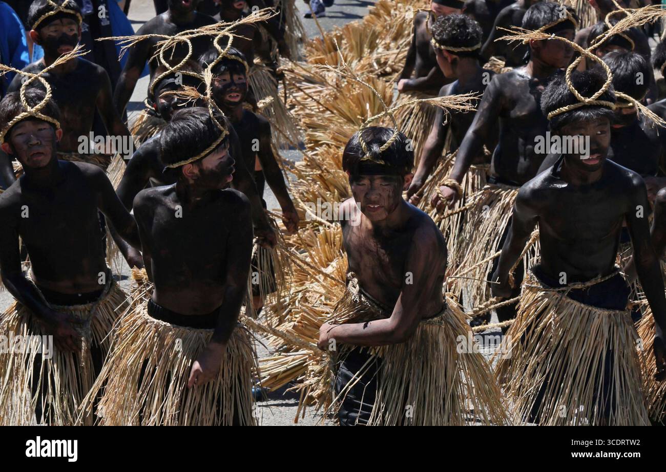 Boys dressed as an oni (demon) pull a rope during the Hisadomi Kannon ...