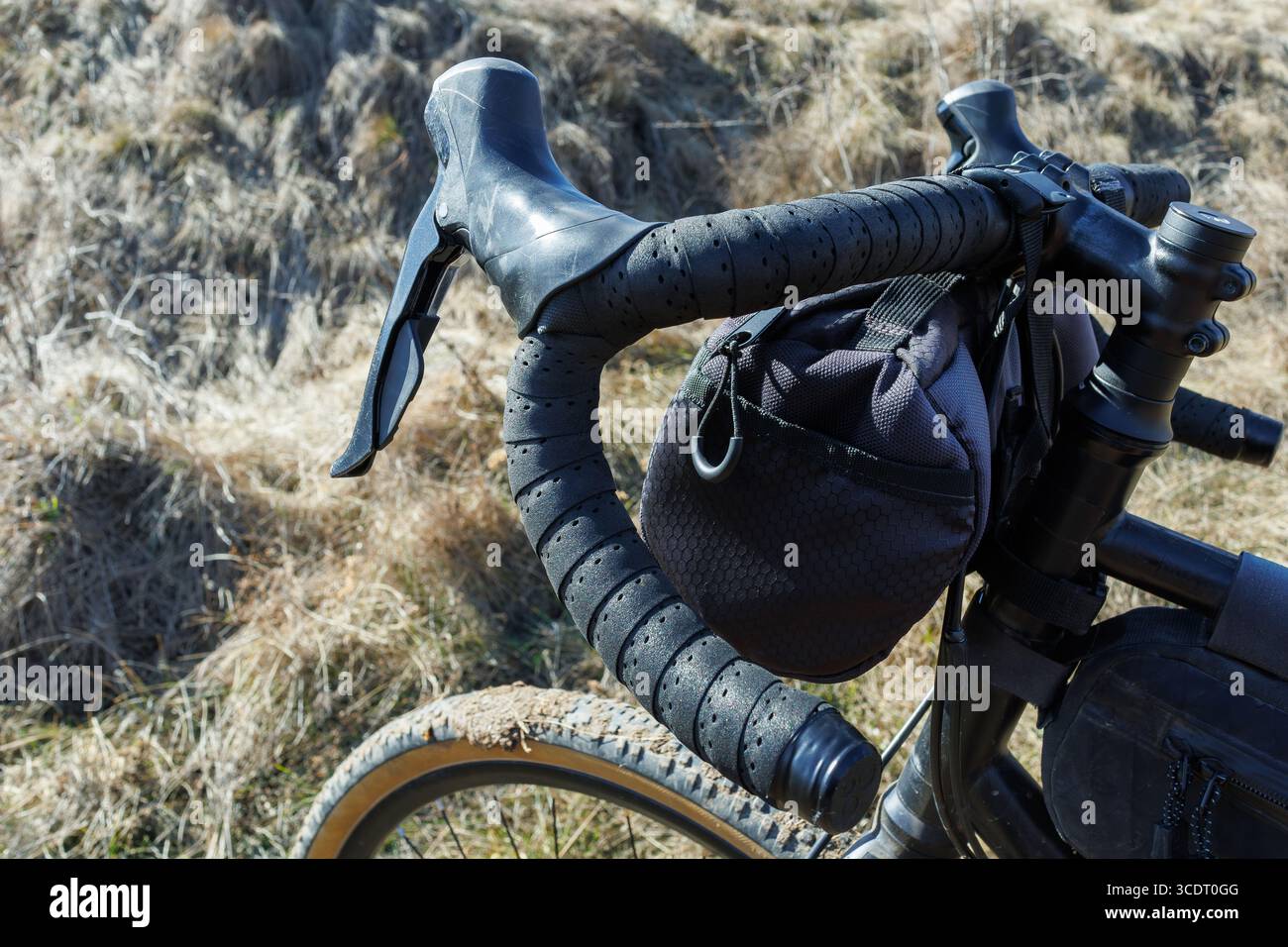 Close-up of a gravel bikes drop handlebars and handlebar bag on a ...