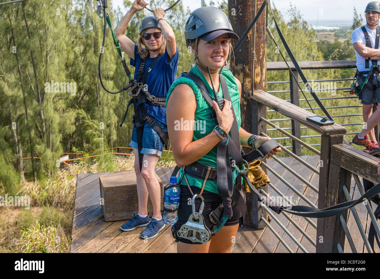 Female guide helping client during a guided zip-line tour at CLIMB ...
