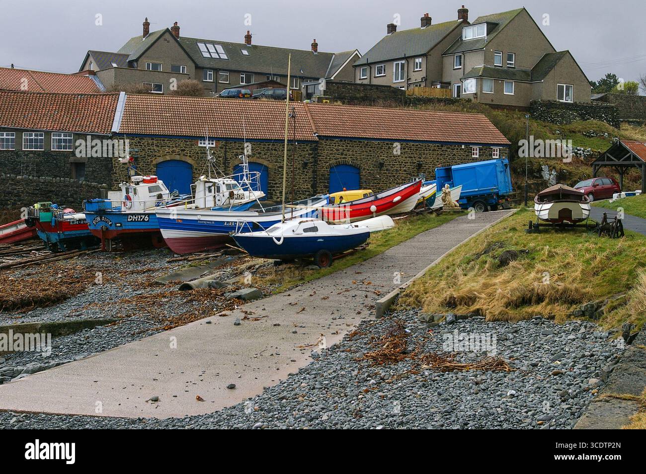 Fishing boats and cottages in the harbour village of Craster ...