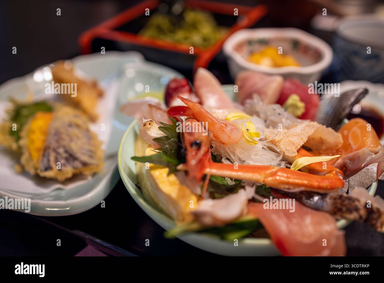 Traditional Japanese kaiseki dinner with assorted sashimi, tempura ...