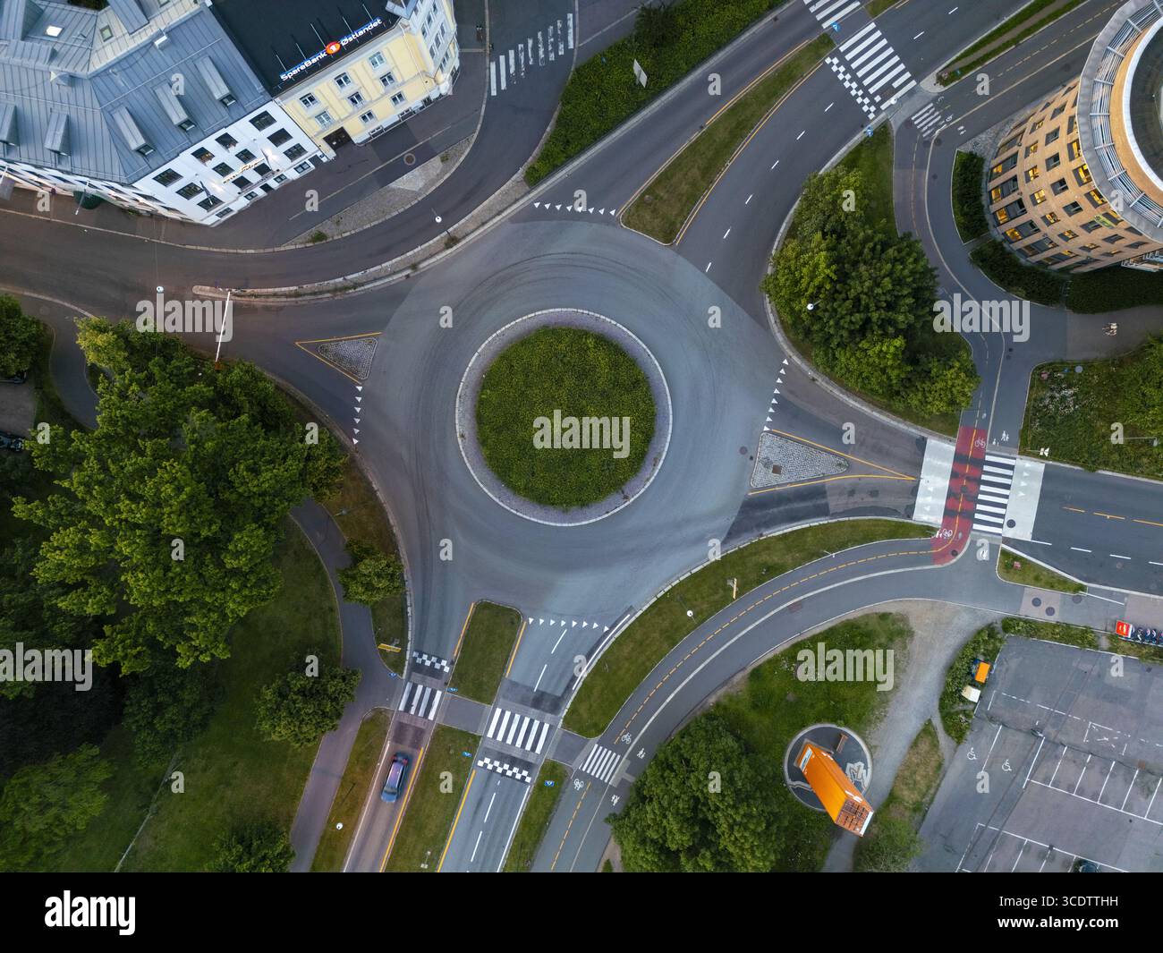 Aerial view of a roundabout's circular green heart amidst the concrete ...
