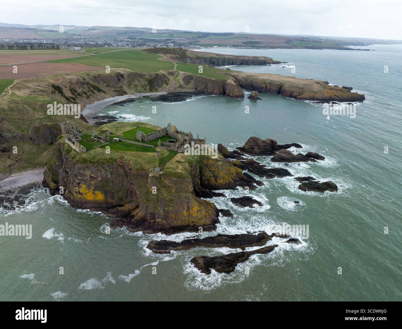 Aerial view of the dramatic Dunnottar Castle ruins perched on a rugged ...