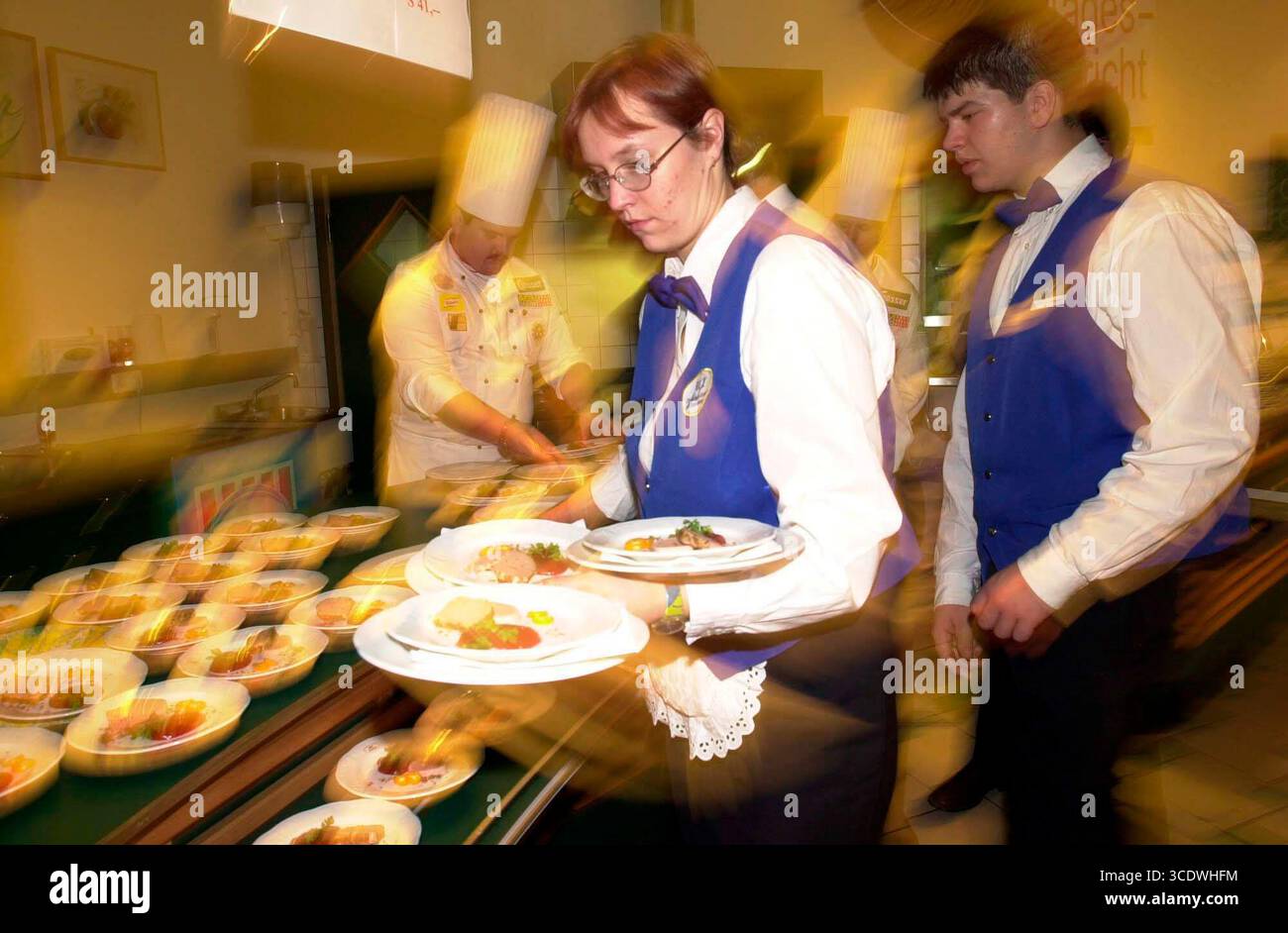 waitress in a restaurant is serving food to the costumers waitress ...