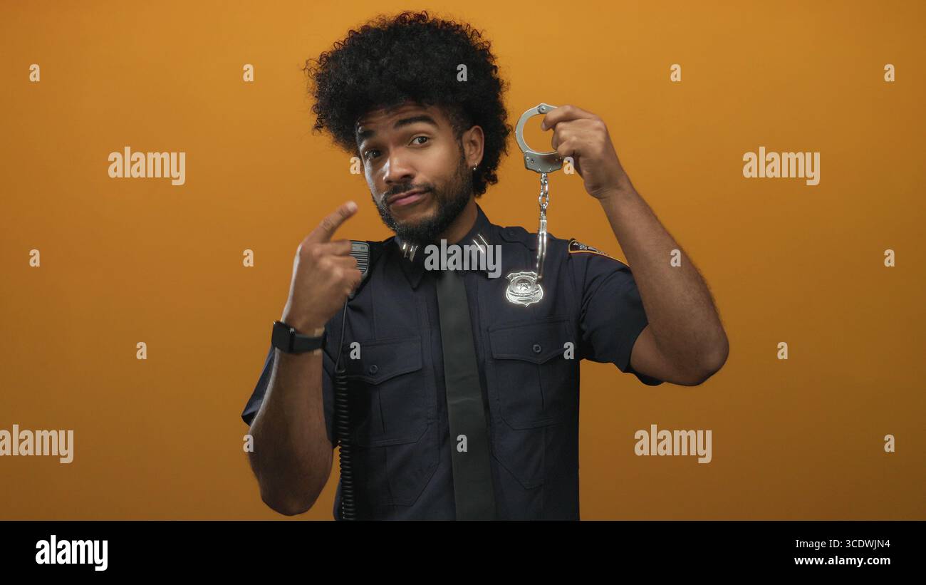 Police officer smiles holding handcuffs hi-res stock photography and ...