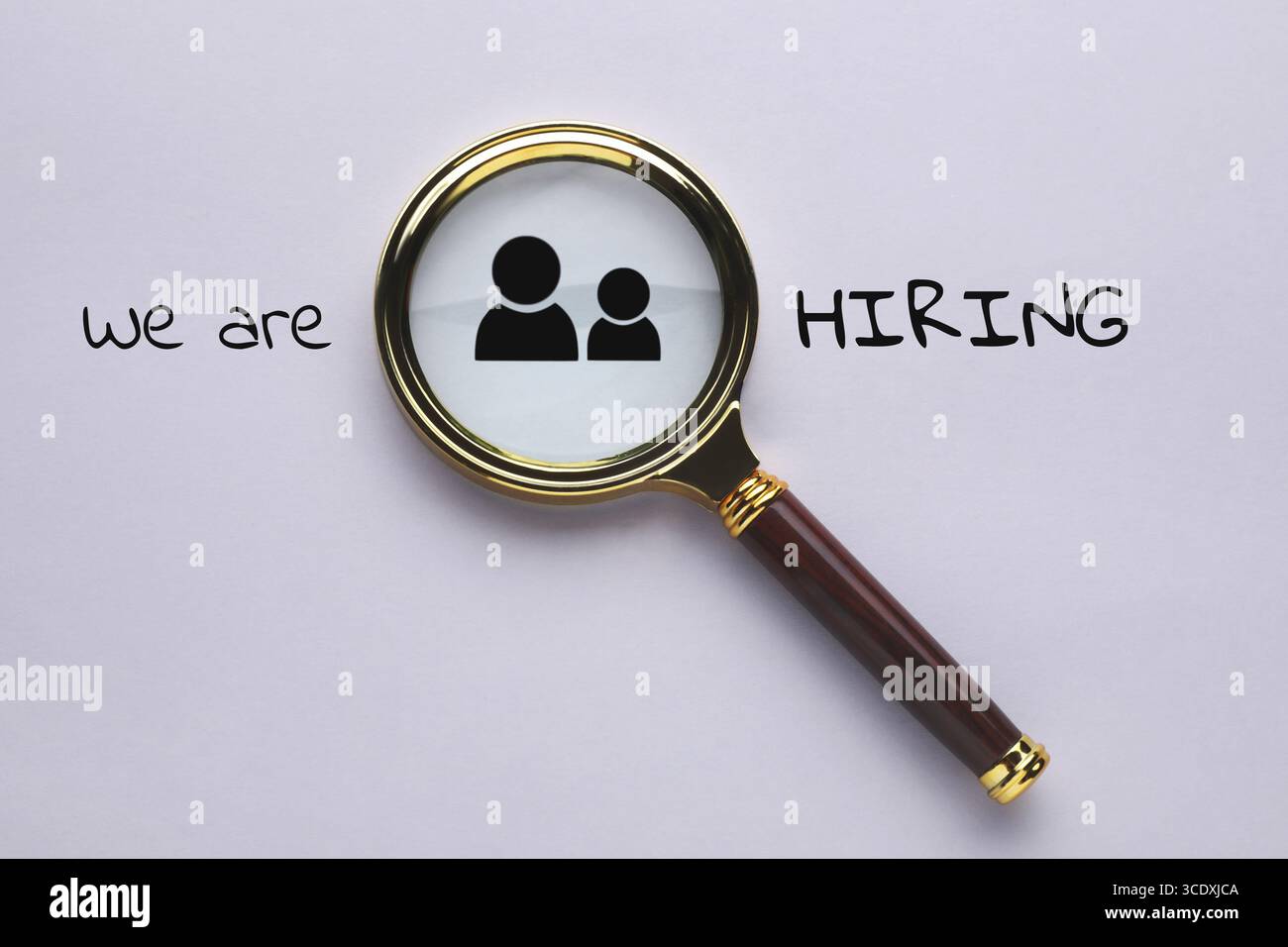 We are hiring. Magnifying glass with human icon and inscription on grey ...