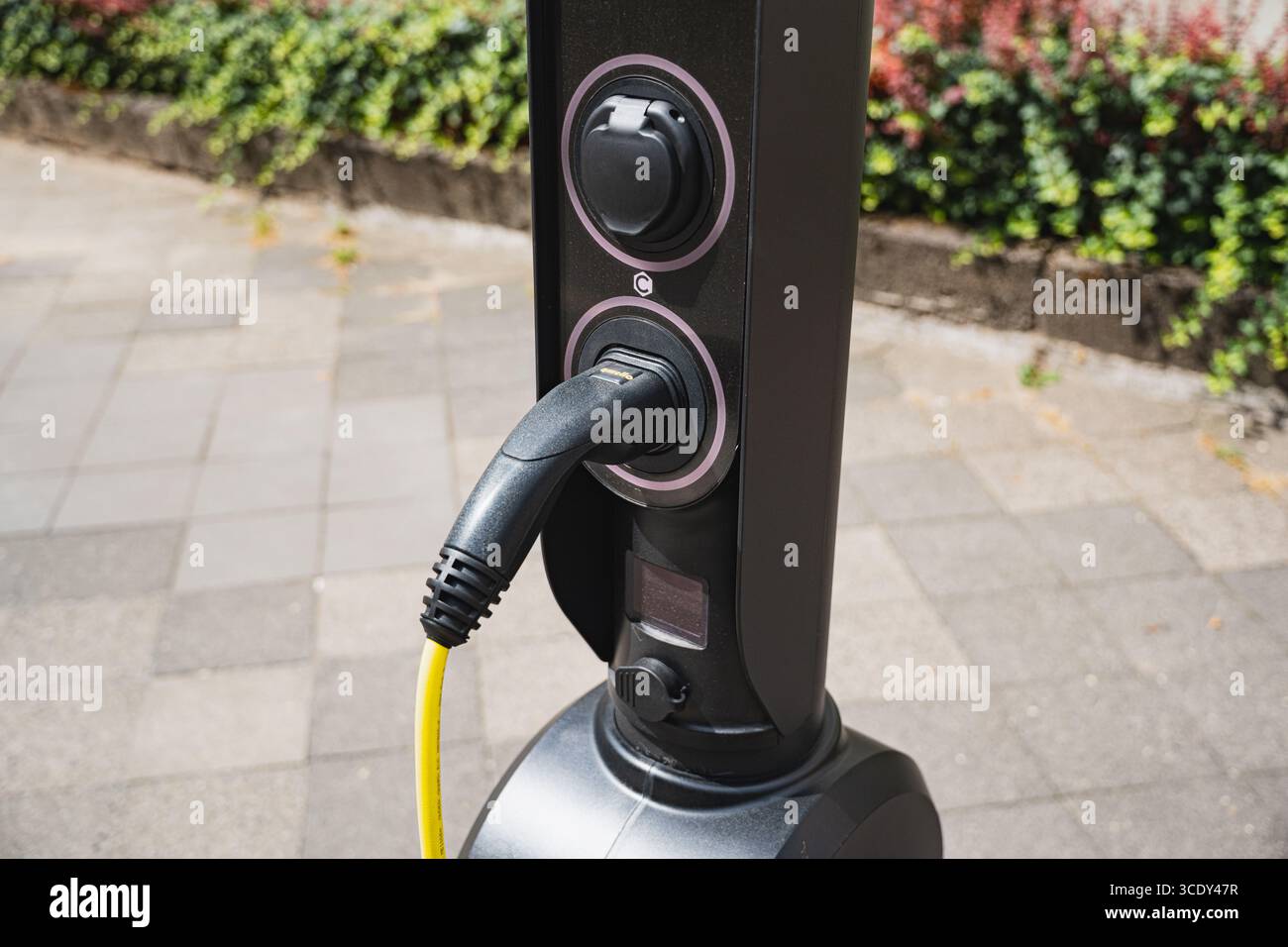 Modern street charging station with cable for electric vehicles Stock ...