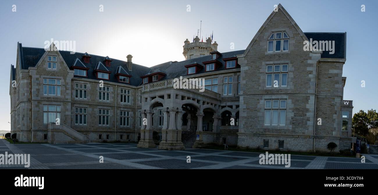 A grand stone mansion with multiple gables and a central tower, set ...