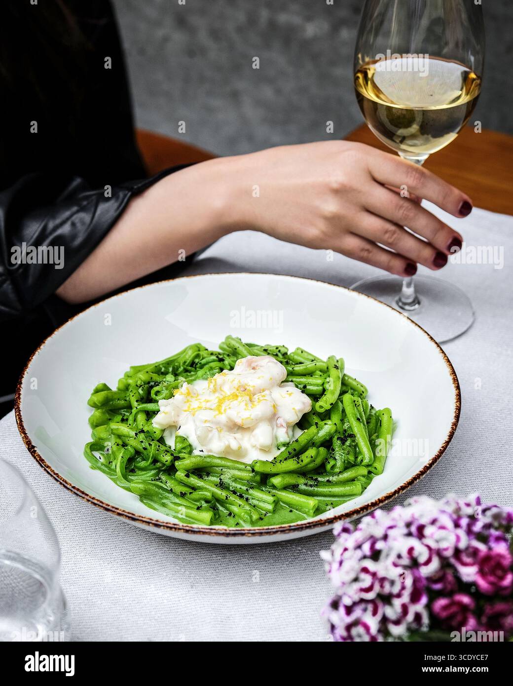 Enjoy a refined dining experience with fresh green pasta and ...