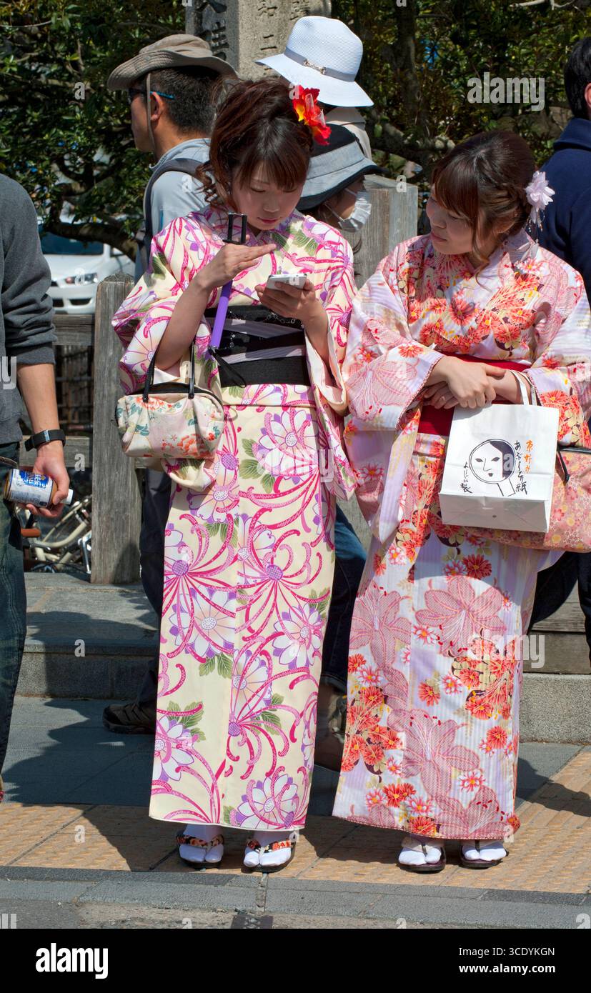 Japanese women dressed in colorful "yukata" (浴衣) cotton robes out for a ...