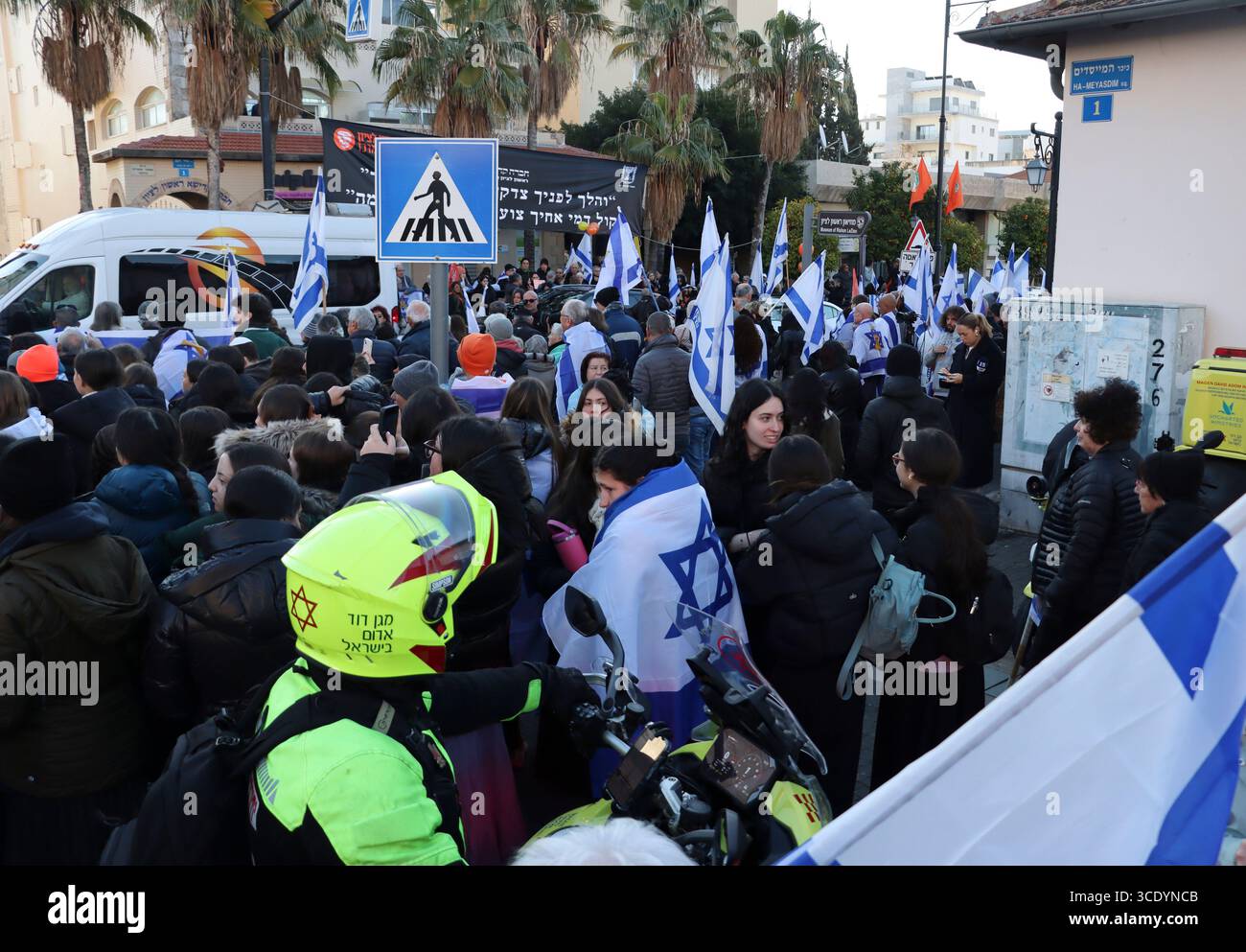 Mourners gather in support of the Bibas family as a convoy carrying the ...