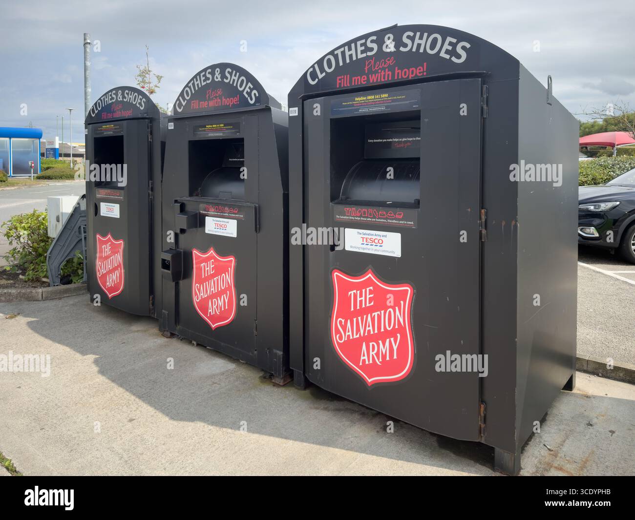 Three recycling bins for clothes and shoes, Formby Merseyside UK August ...