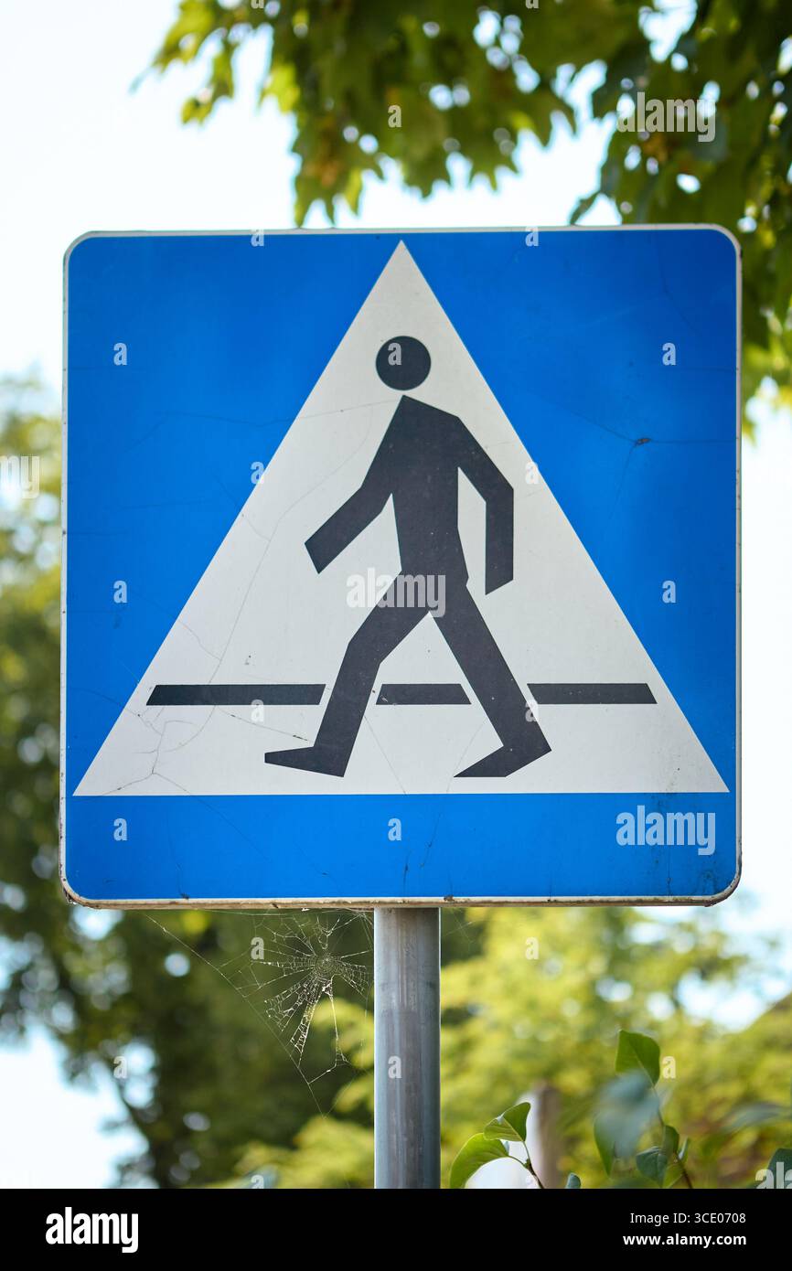 A blue pedestrian crossing sign Stock Photo - Alamy