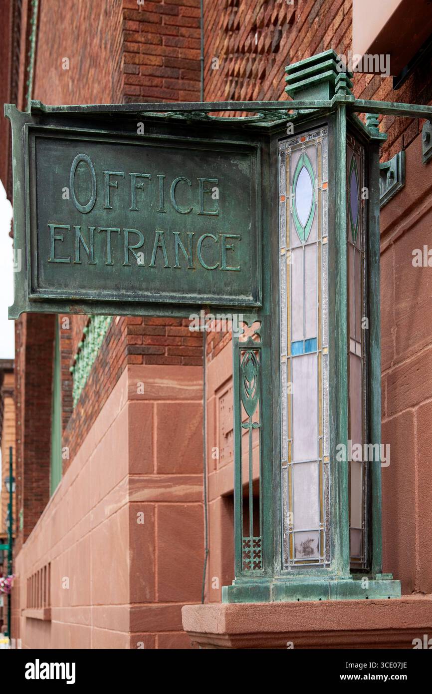 Detail of historic bronze sign and pole in the craftsman style on the ...