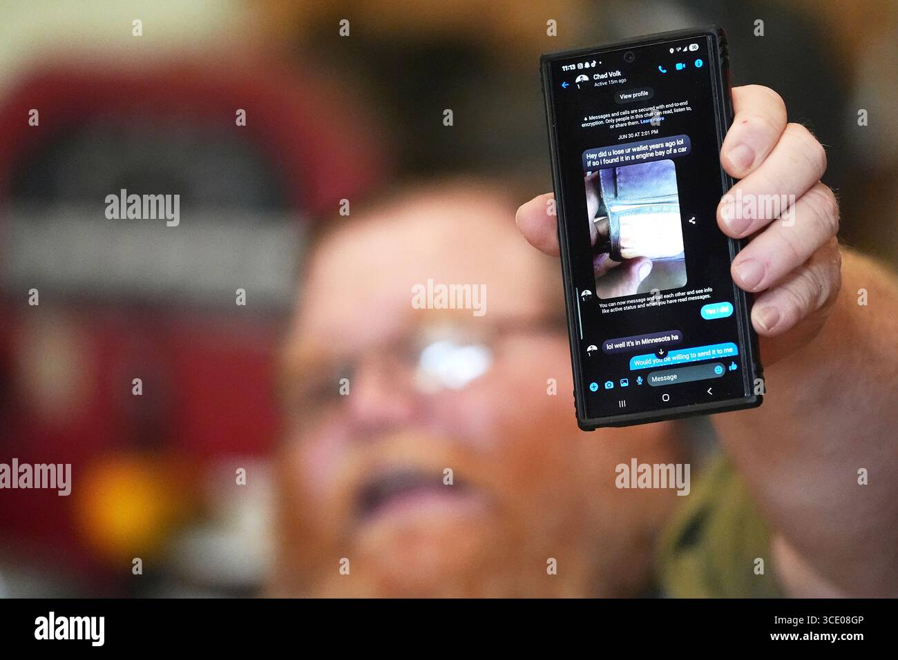 Richard Guilford holds up a chat message he received from Chad Volk ...