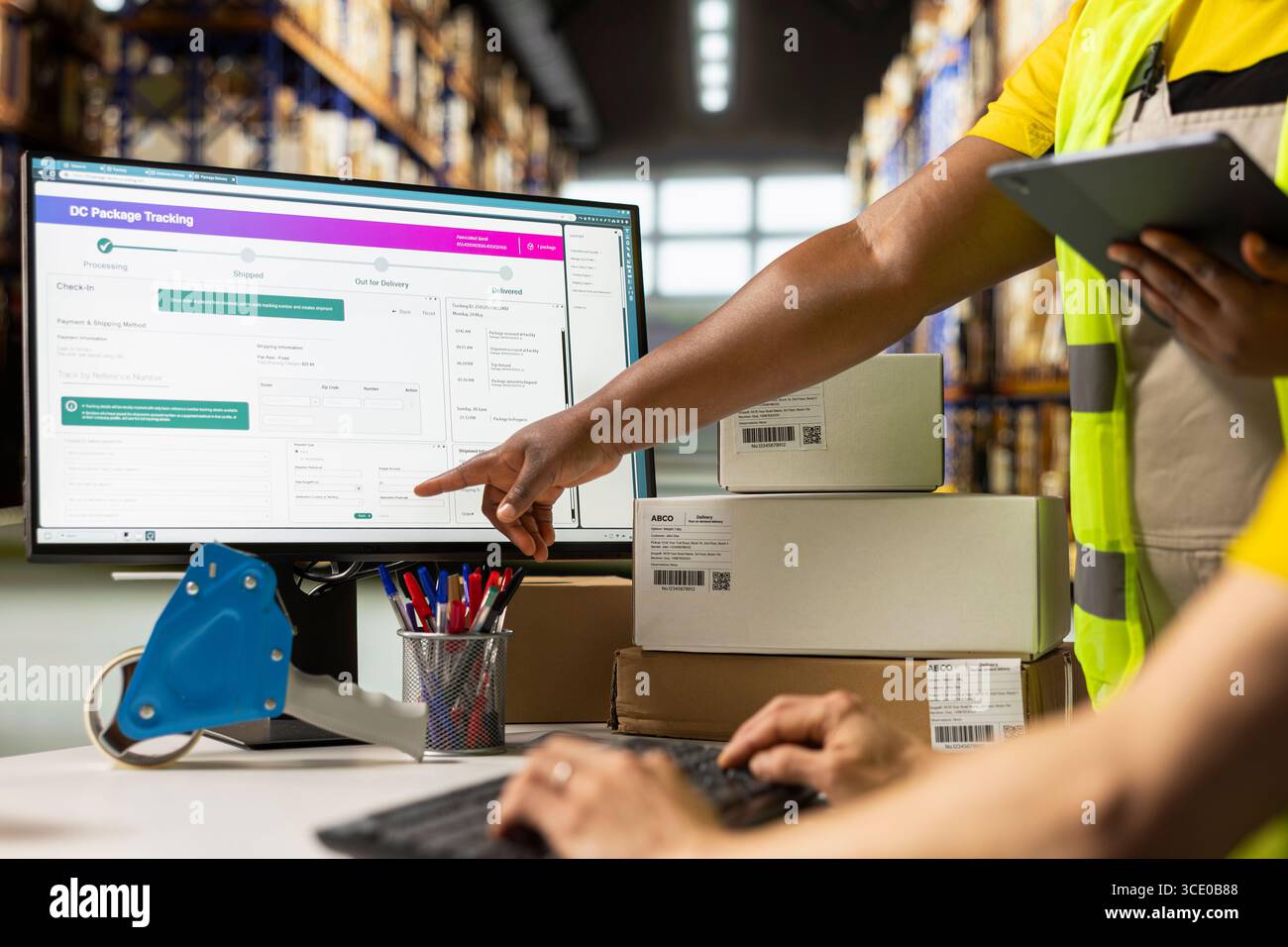 Fulfillment center workers managing shipment tracking systems ...